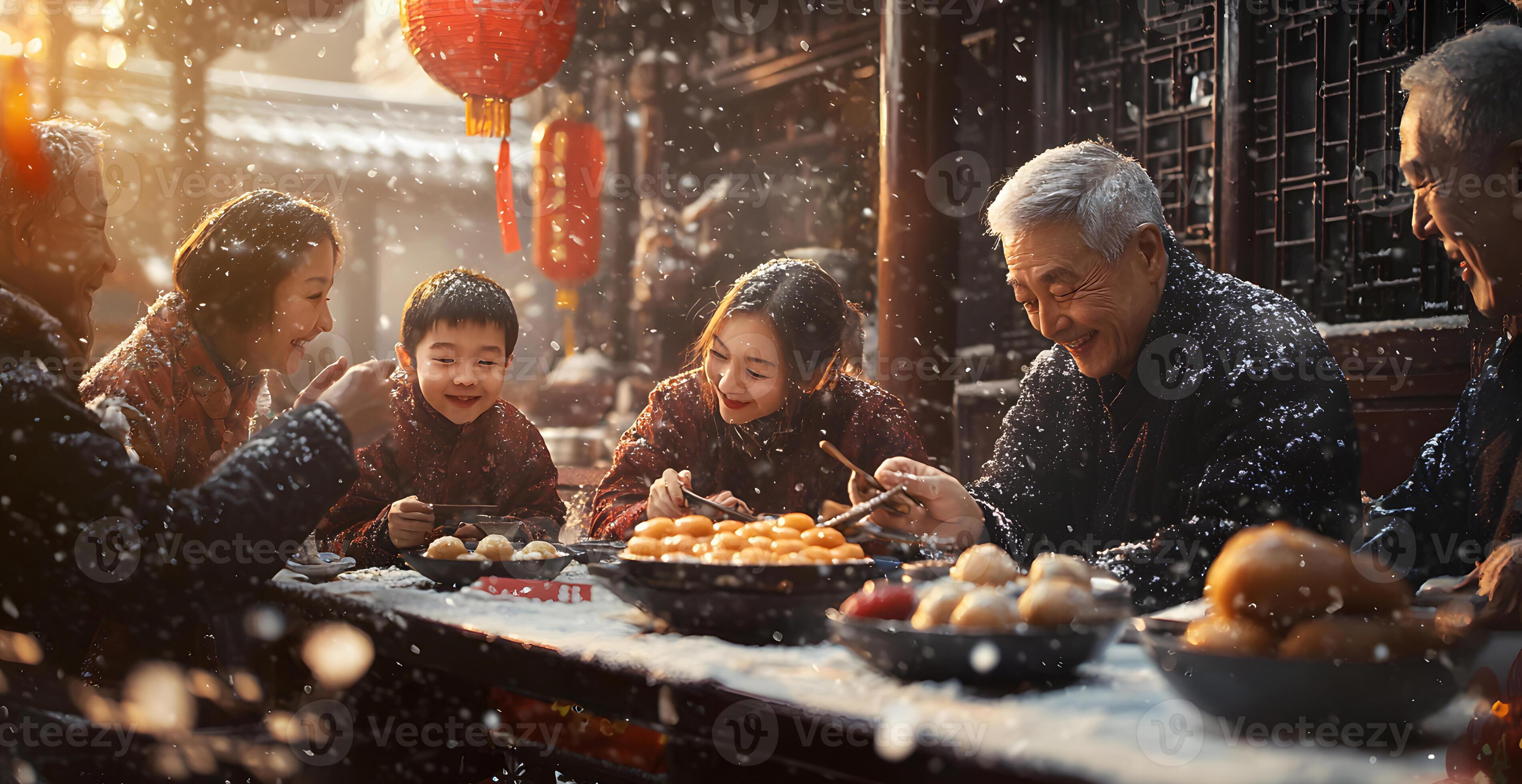 Family celebrating Dongzhi Festival around table with seasonal food. Winter solstice and ...