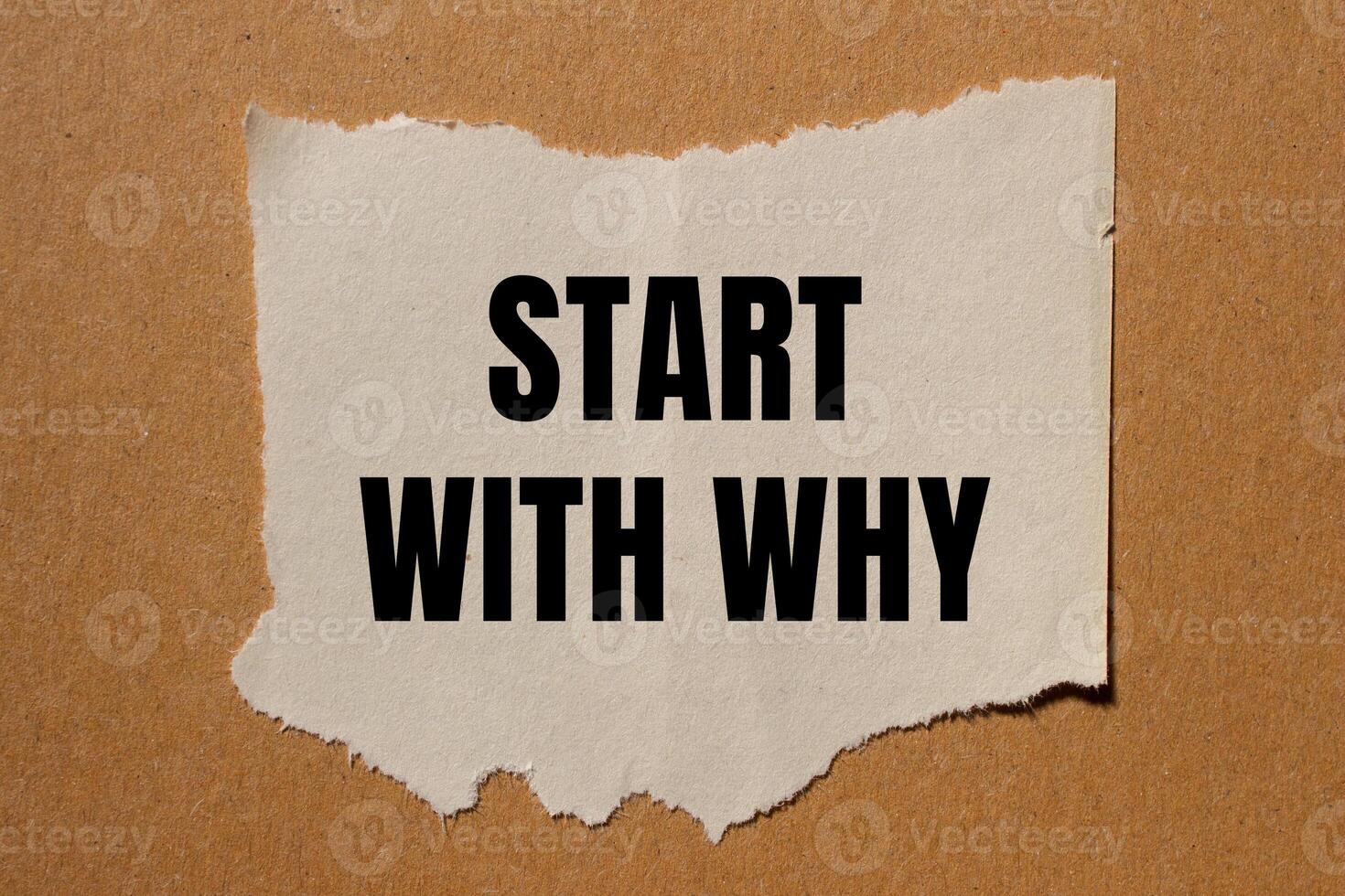 Start with why message written on ripped torn paper piece with brown background. Conceptual ...
