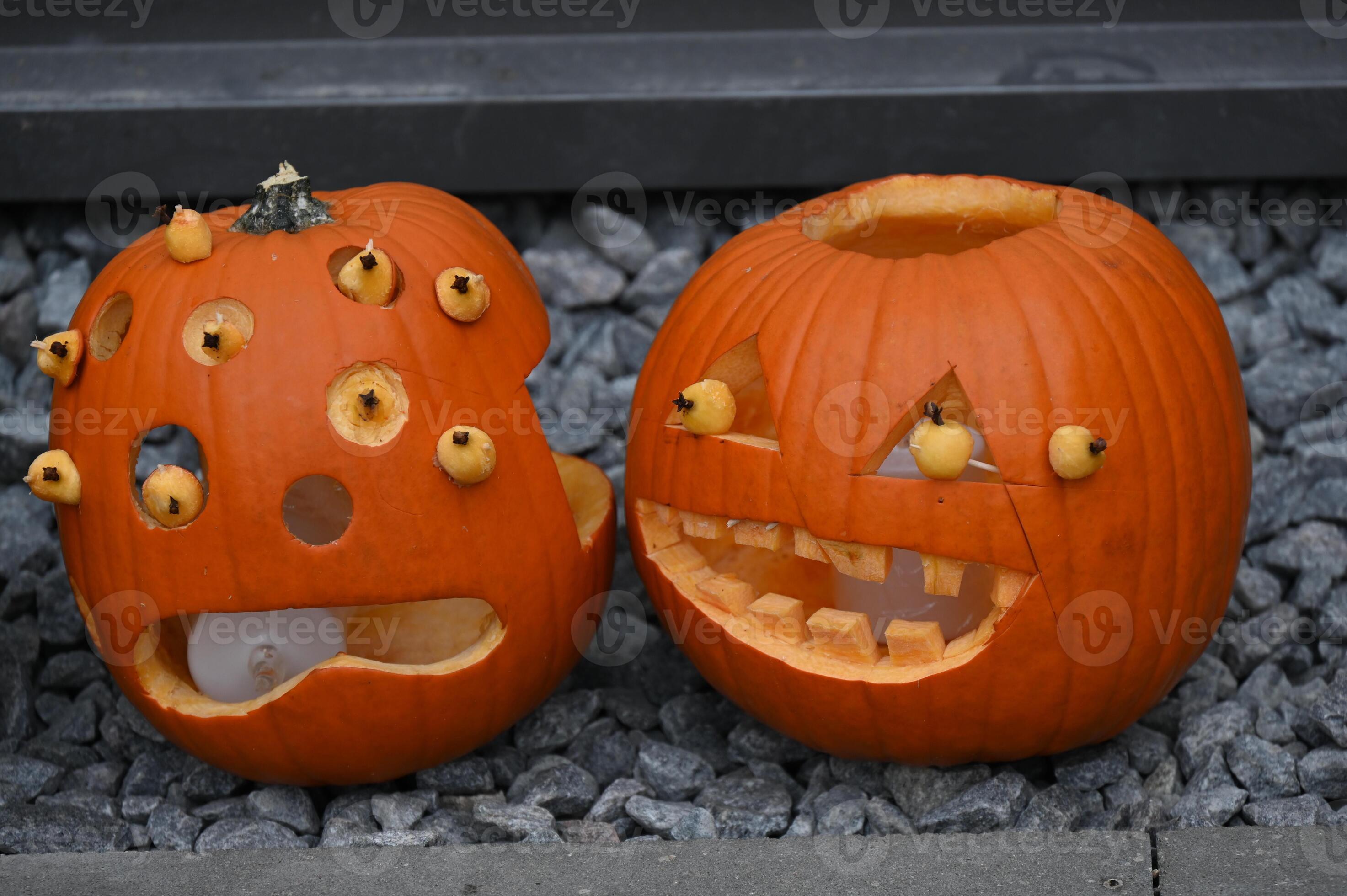 two carved pumpkins with eyes and teeth 52584285 Stock Photo at Vecteezy