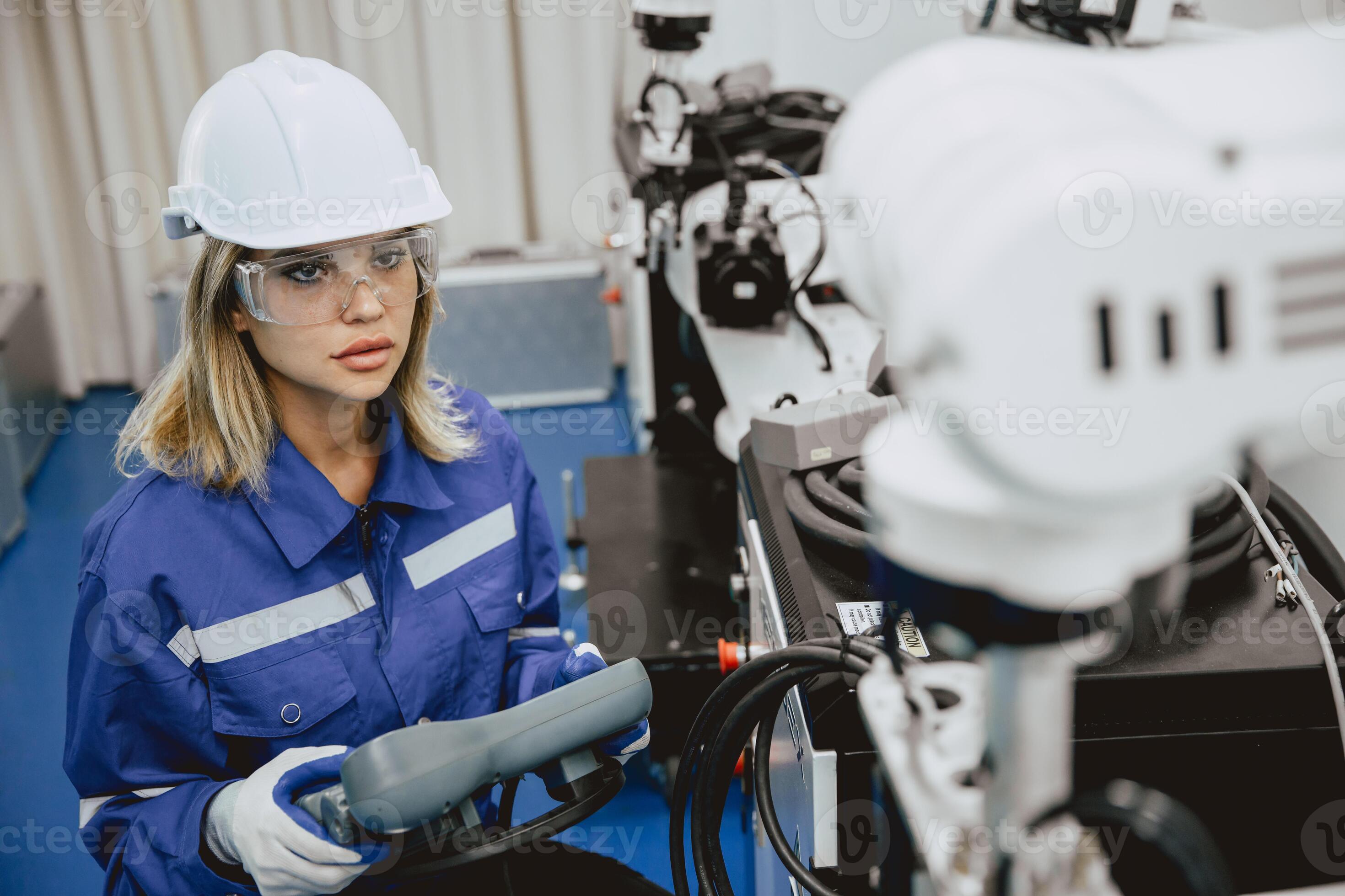 Engineer women university student learn to manual hand control operate industry robot arm with ...