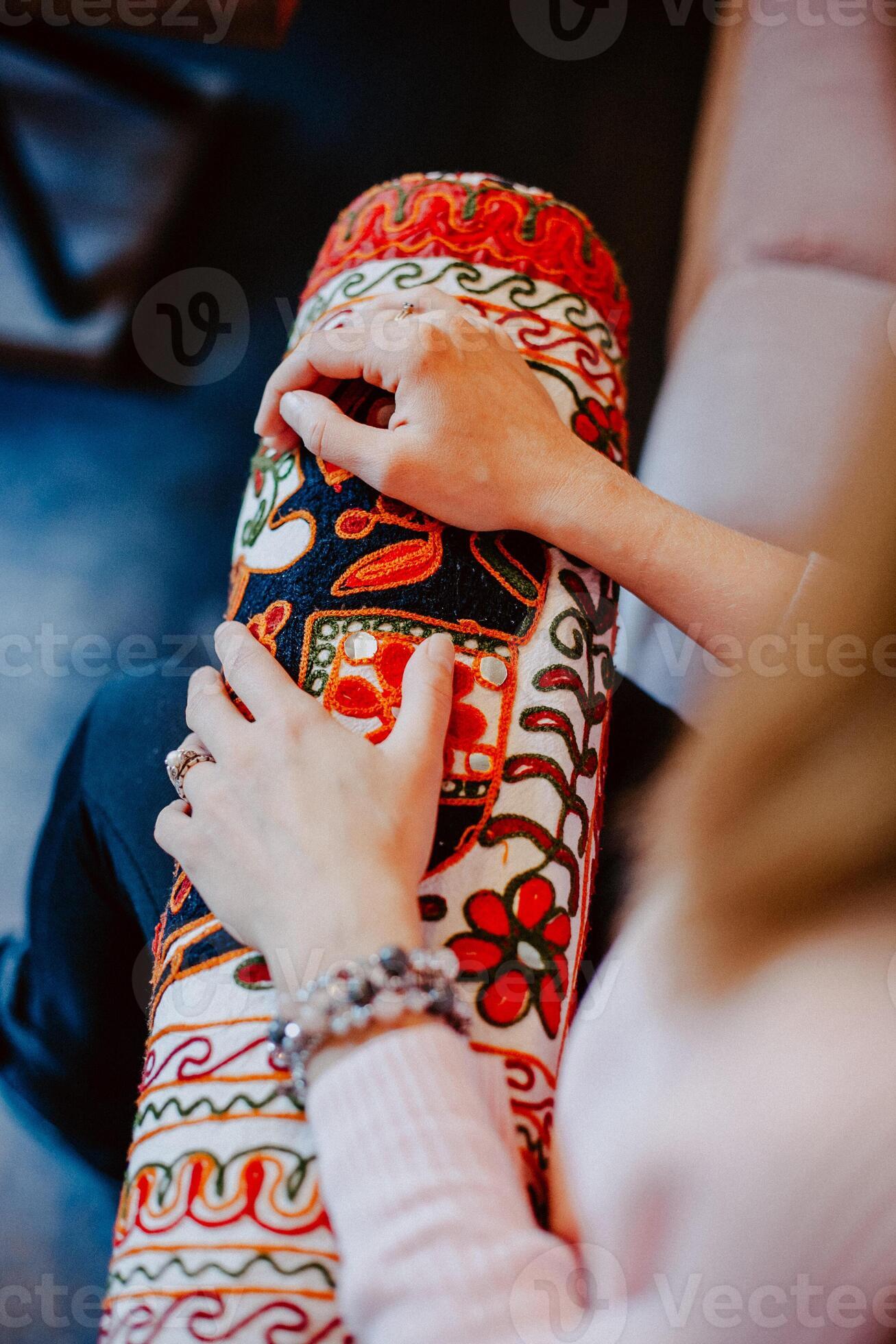 a young white girl holds a yoga Mat in her hands, a cover for a Mat with Indian motifs and ...
