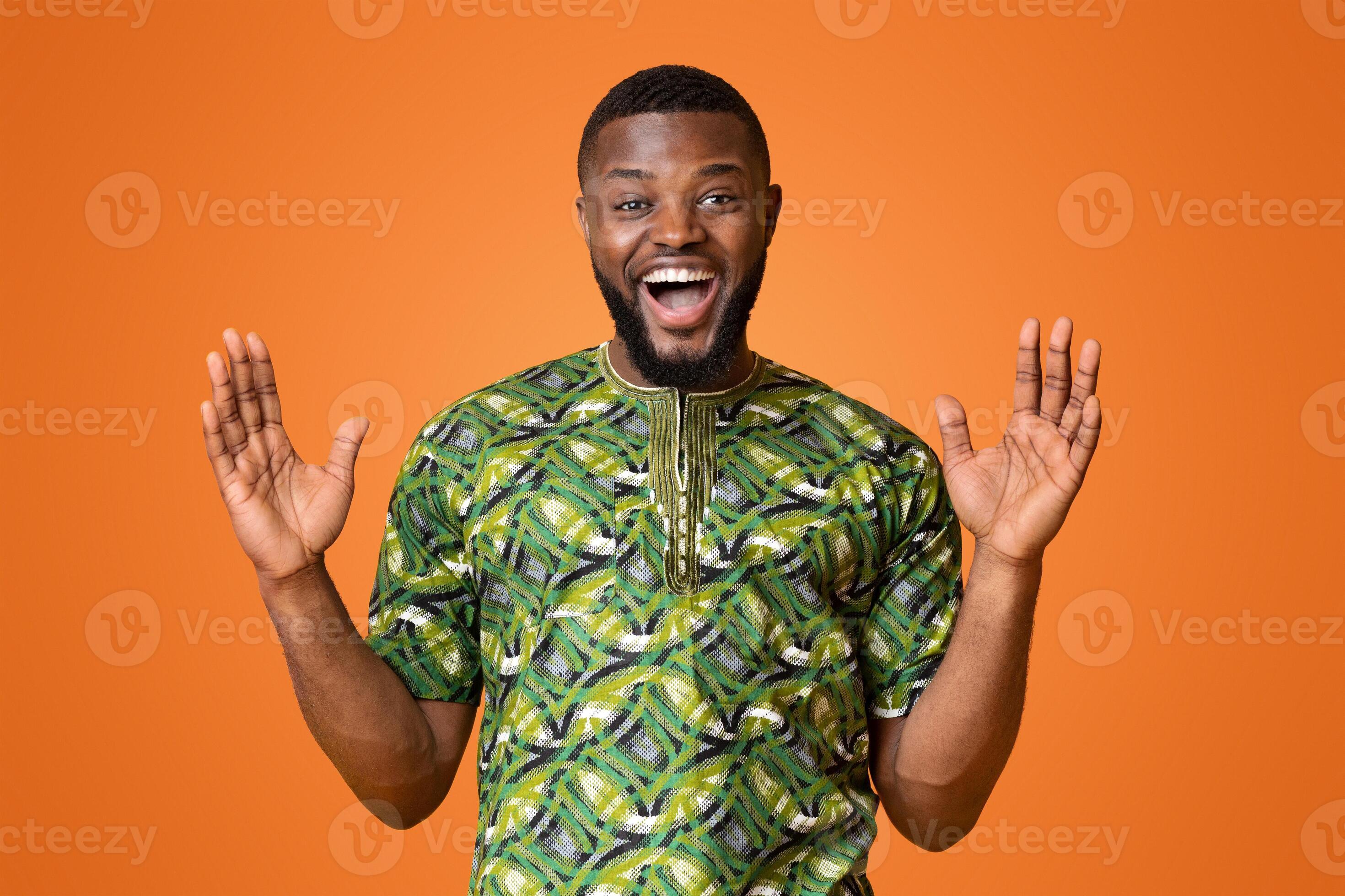 Surprised african man with hands up looking at camera over yellow studio background 53046449 ...