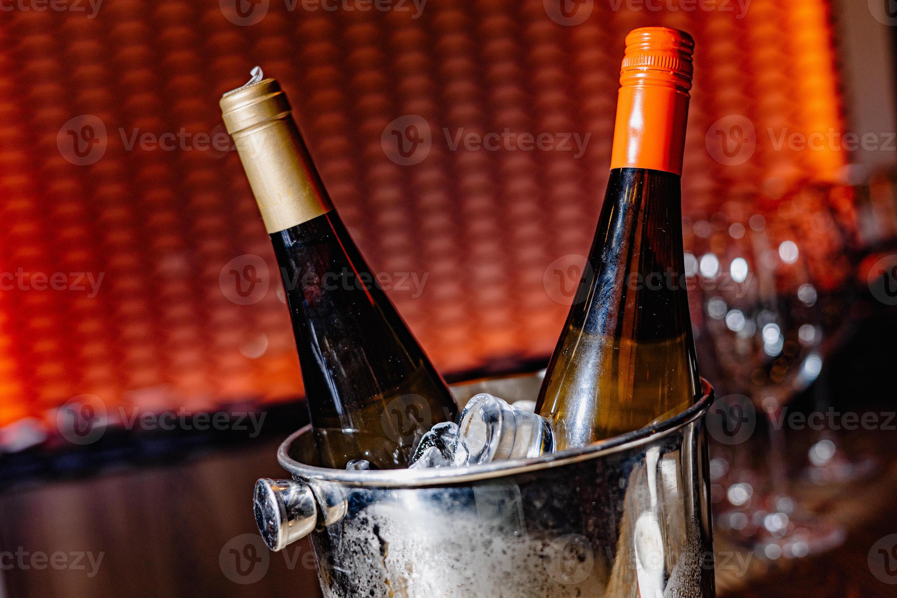 Chilled Elegance Two wine bottles nestled in a frosty ice bucket, reflecting a world of ...