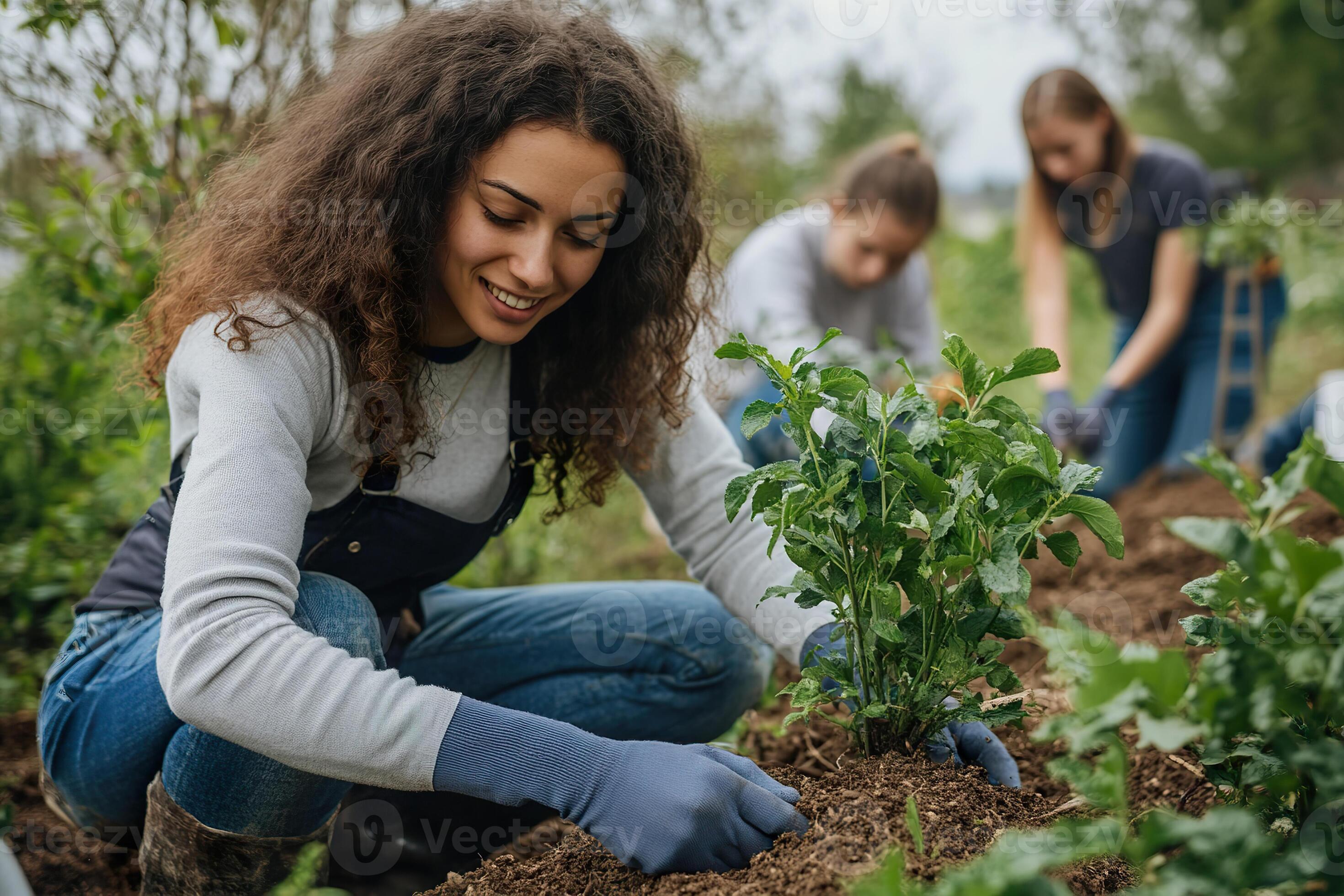 Volunteers engage in tree planting activity to promote community sustainability efforts ...