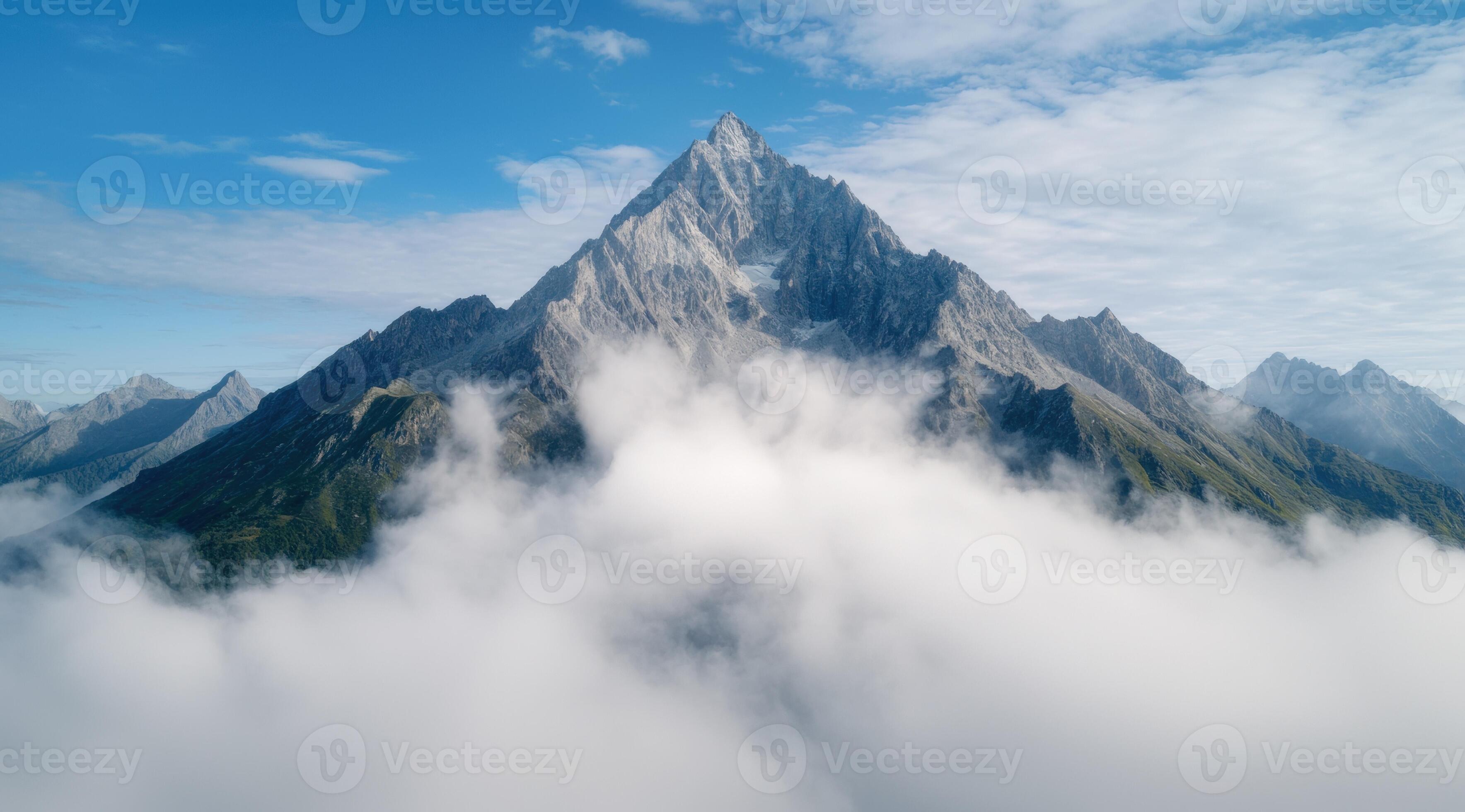 Majestic snow capped mountain peak rising above the clouds 53194834 ...