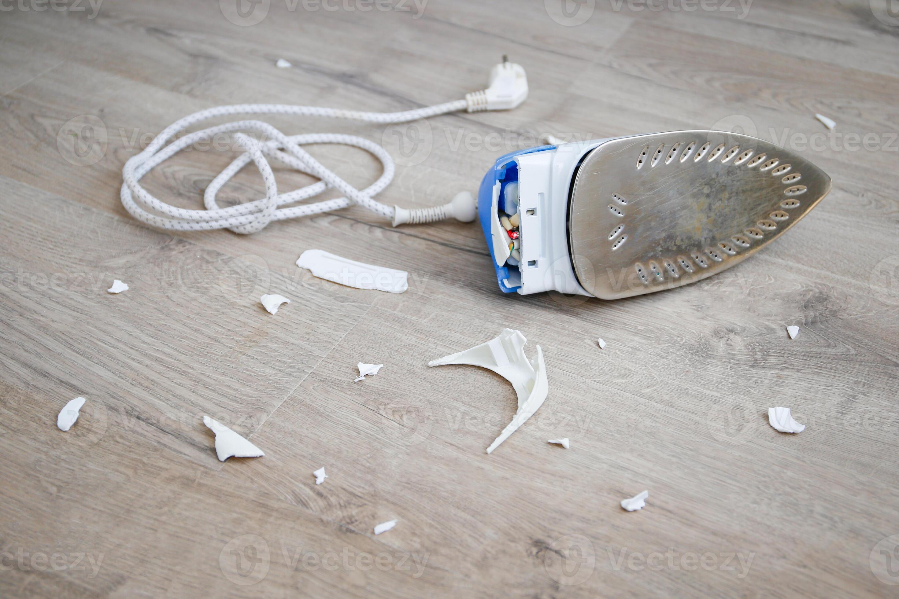 The iron fell to the floor and broke. Breakdown of household appliances. 53235194 Stock Photo at ...