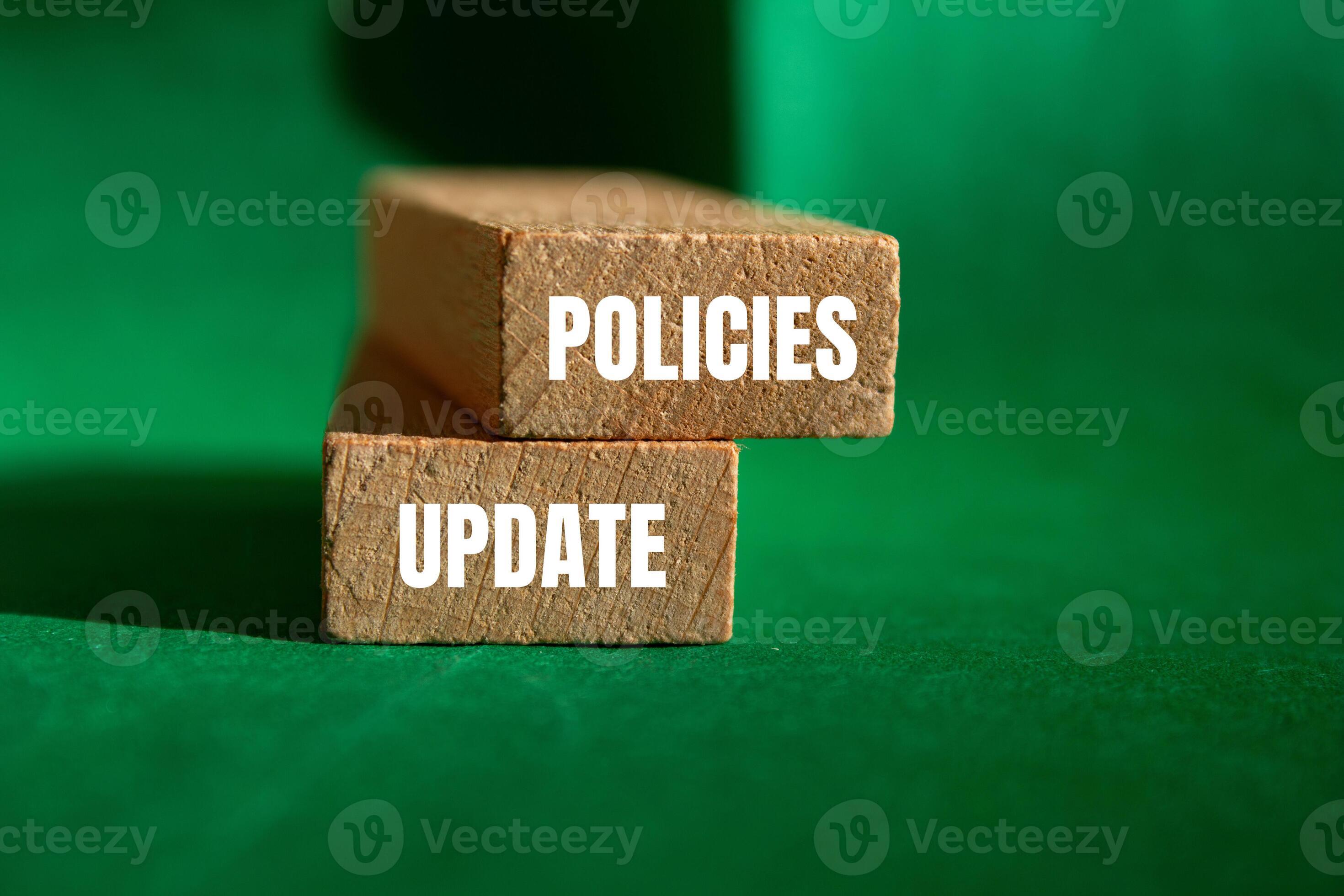 Policies update message written on wooden blocks with green background. Conceptual policies ...