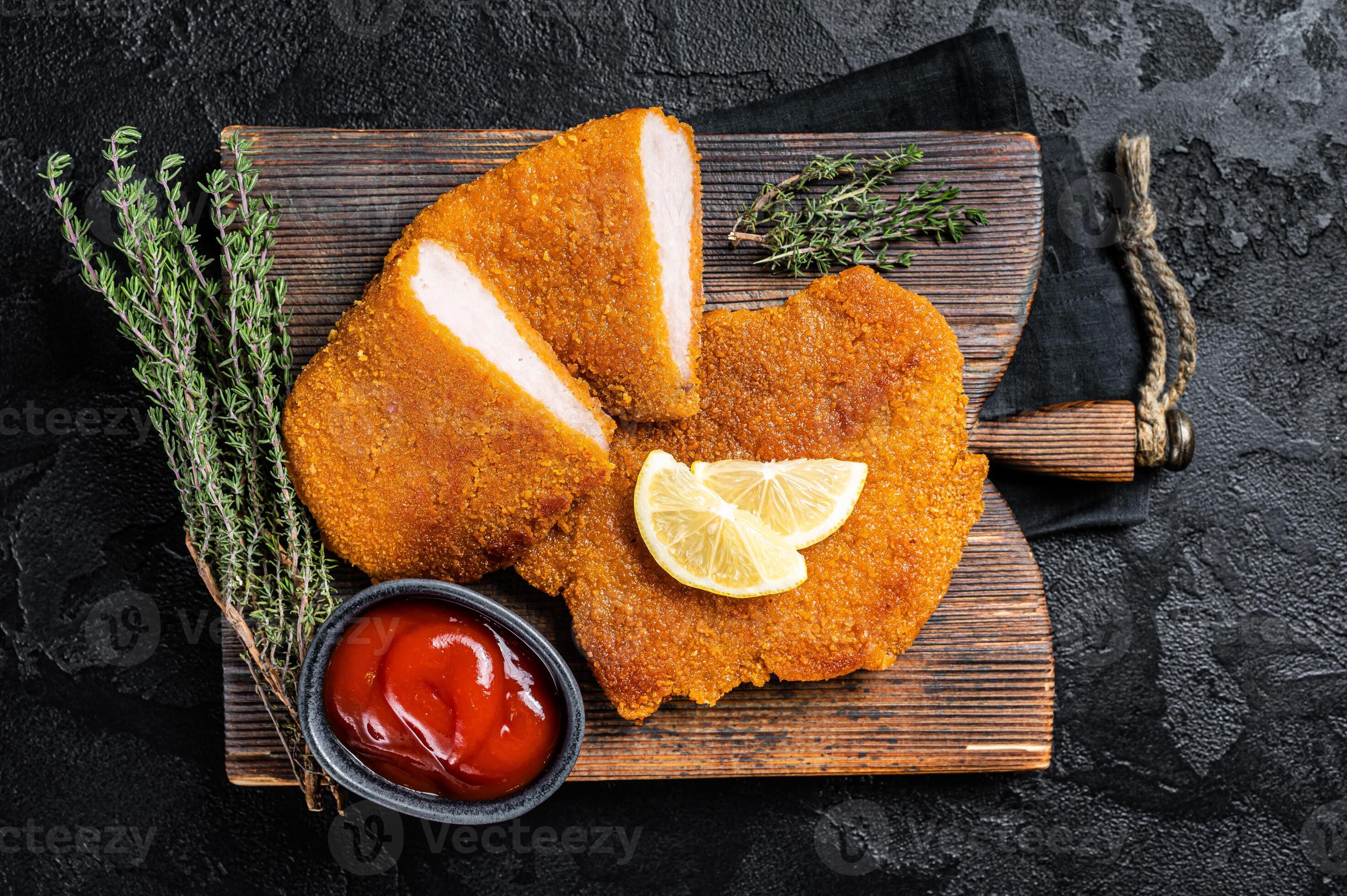 Viennese veal escalope, fried meat Schnitzel steak. Black background. Top view 53510348 Stock ...