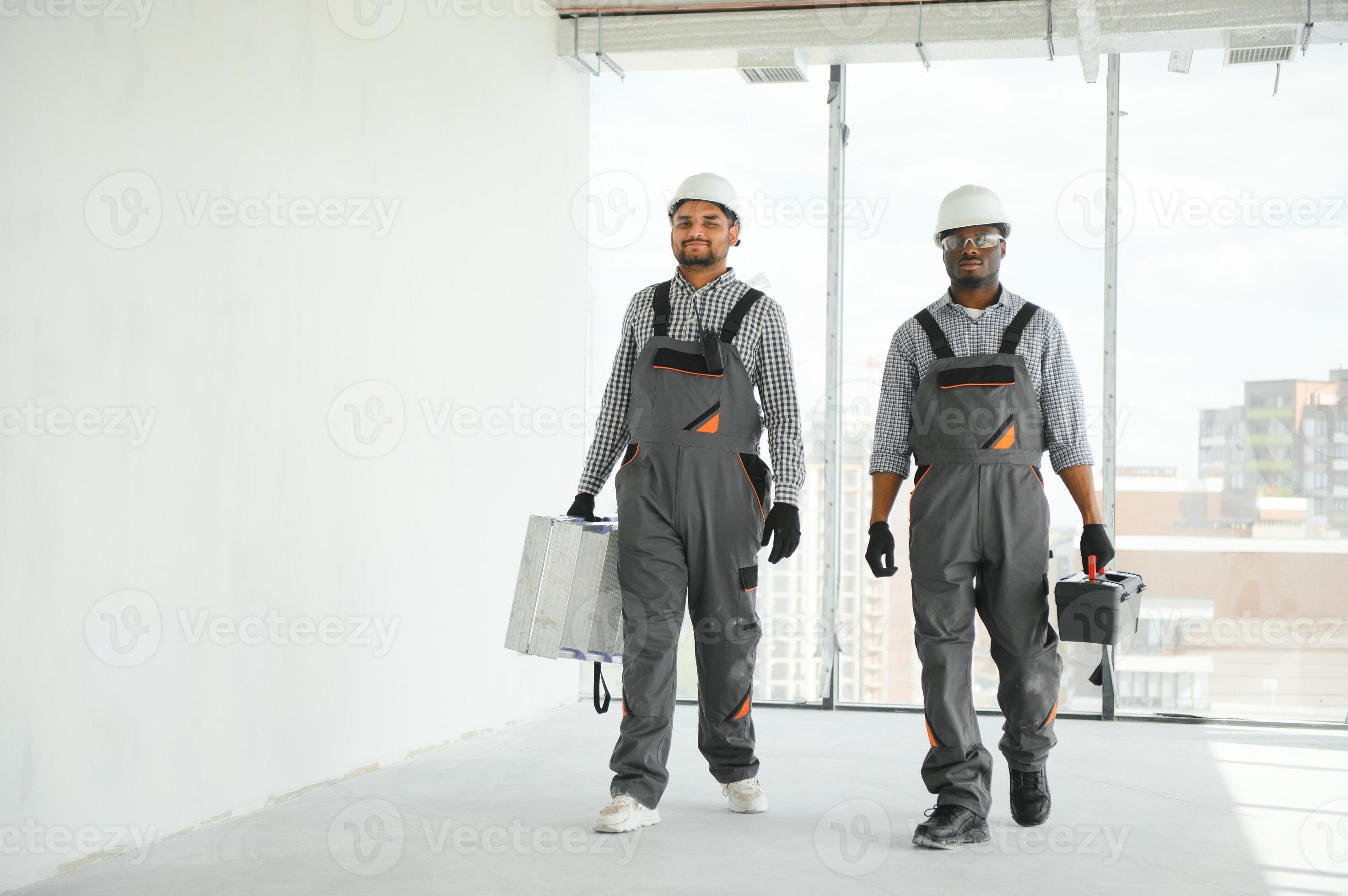 multicultural builders in hardhats at construction site 53525097 Stock Photo at Vecteezy