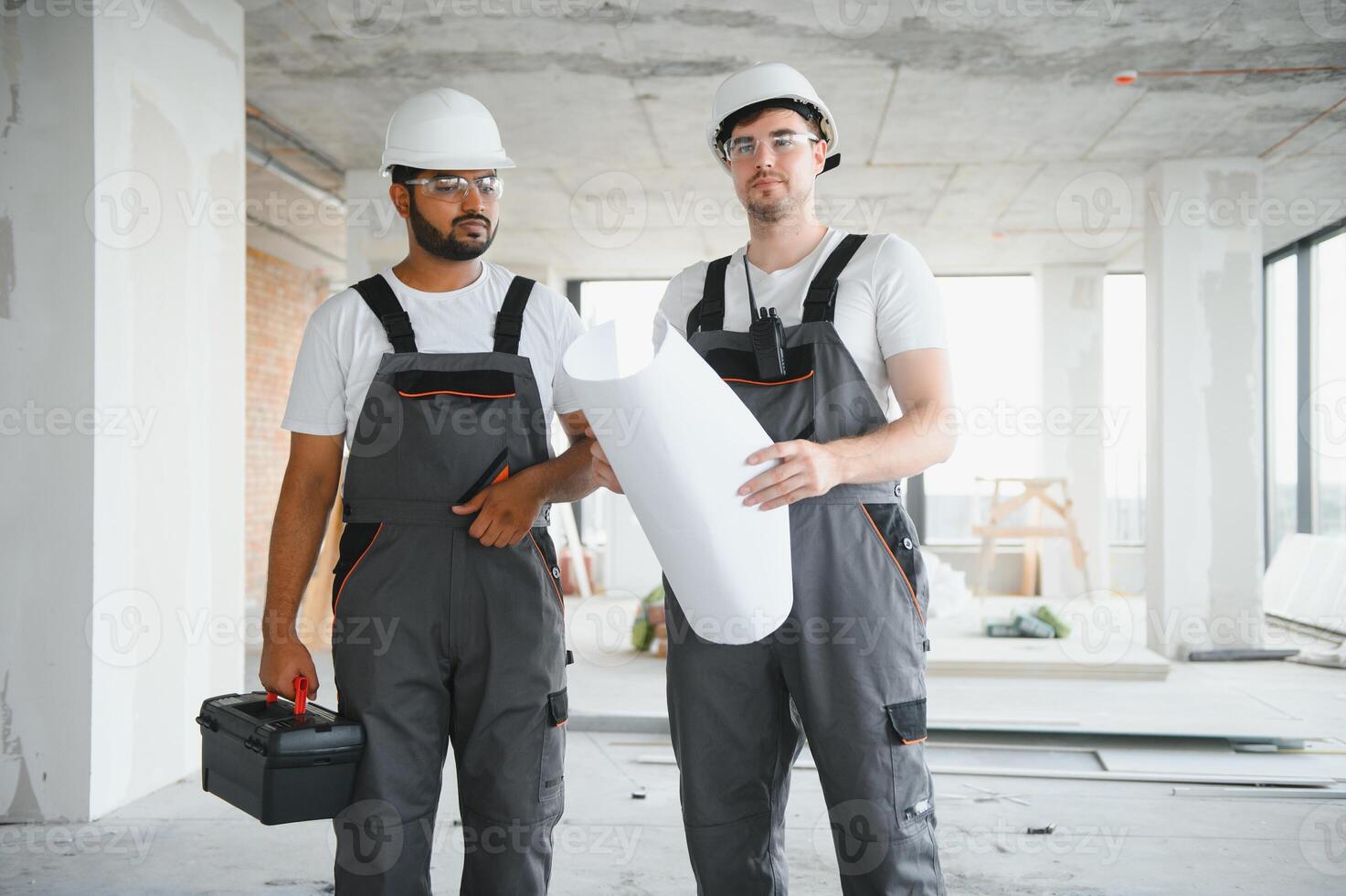 multicultural builders in hardhats at construction site 53525988 Stock Photo at Vecteezy