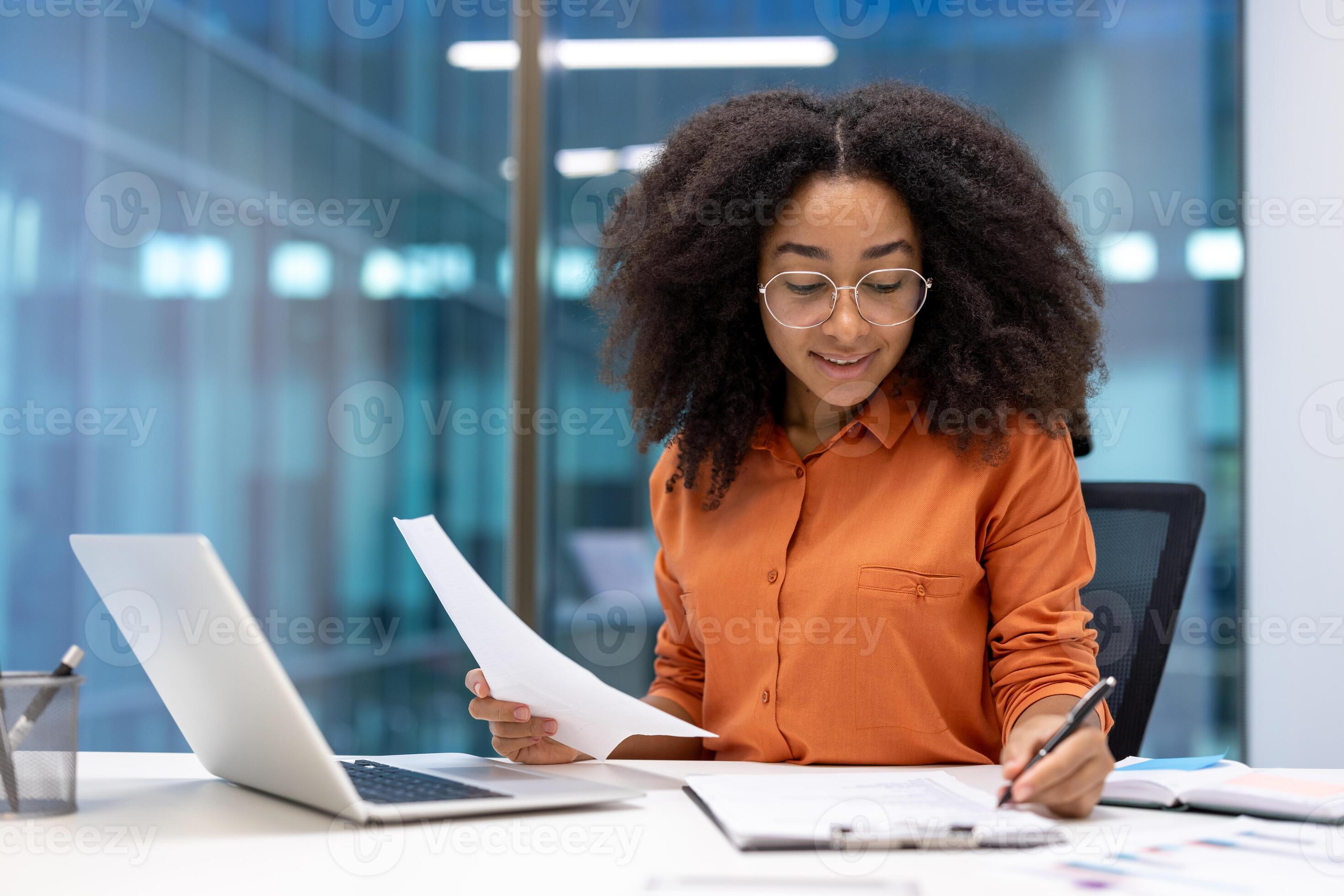 Young Woman Businesswoman Focused At Her Workspace Reviewing Documents