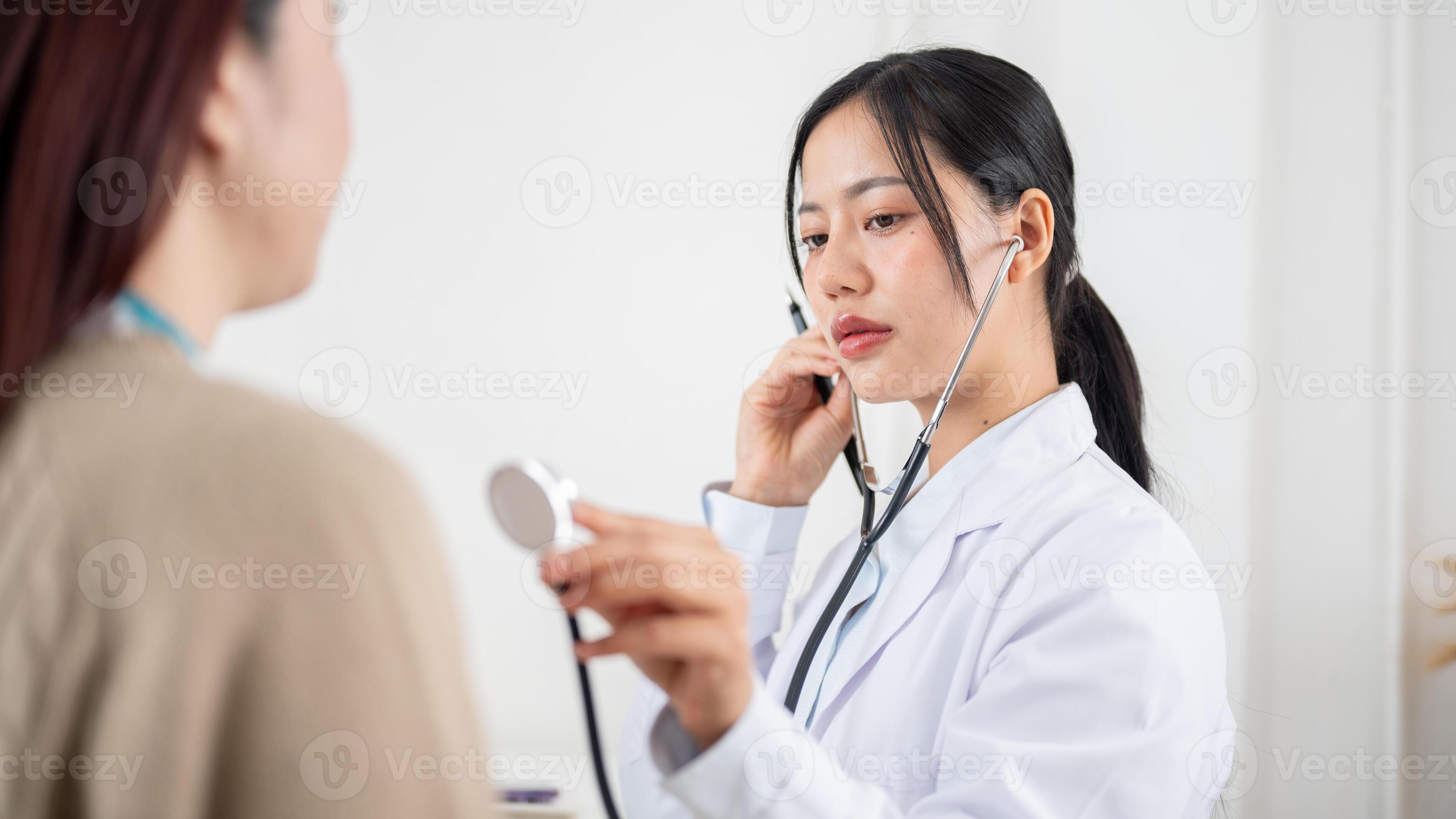A doctor using a stethoscope to listen to a patient's lung and heartbeat sounds. 53609511 Stock ...