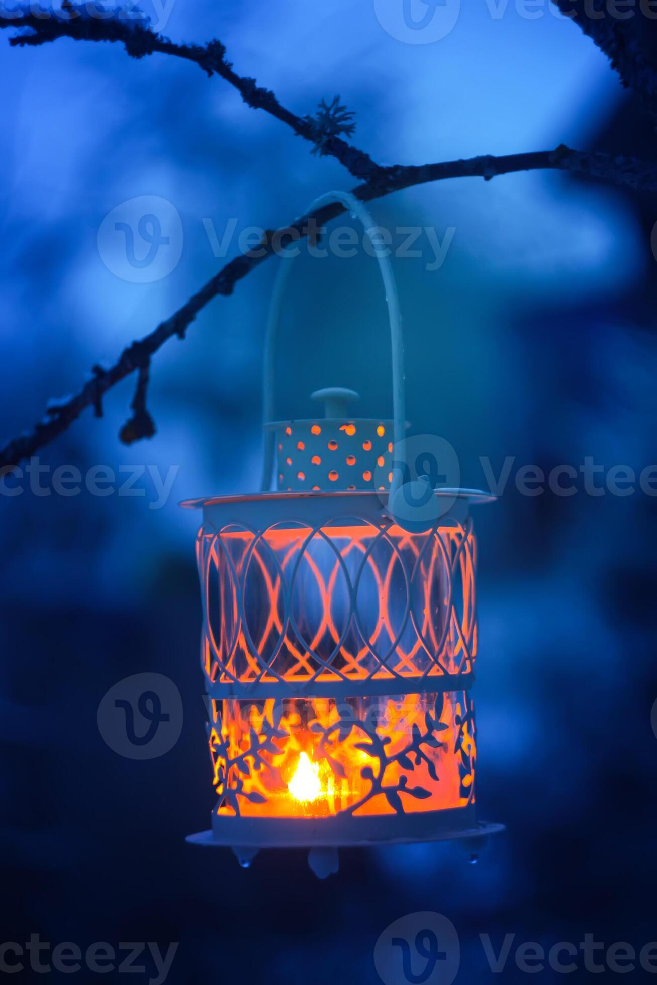 Decorative Christmas lantern with burning candle hanging on snow ...