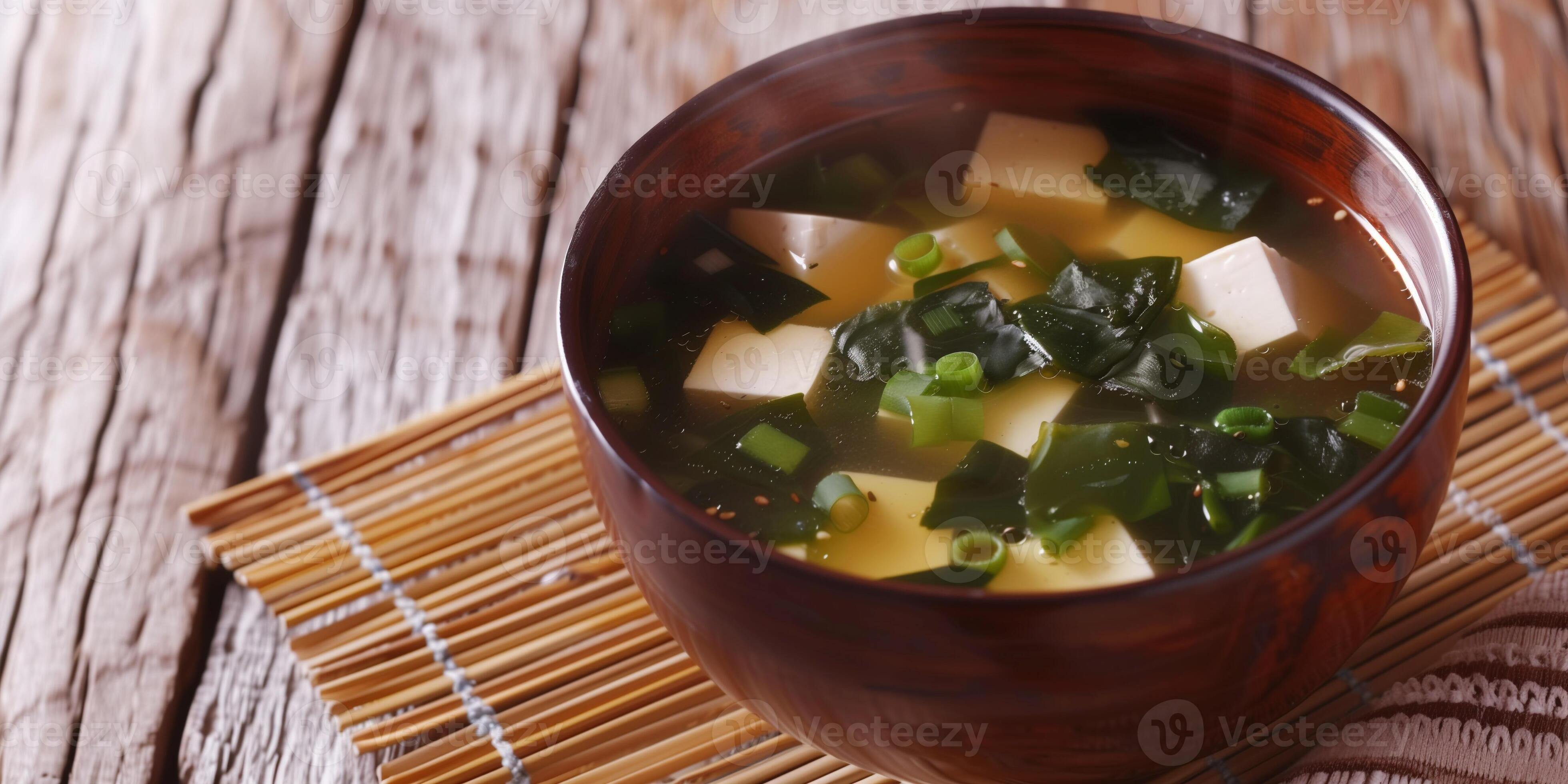 Miso soup with tofu, seaweed, and scallions in a traditional lacquer bowl, photorealistic ...