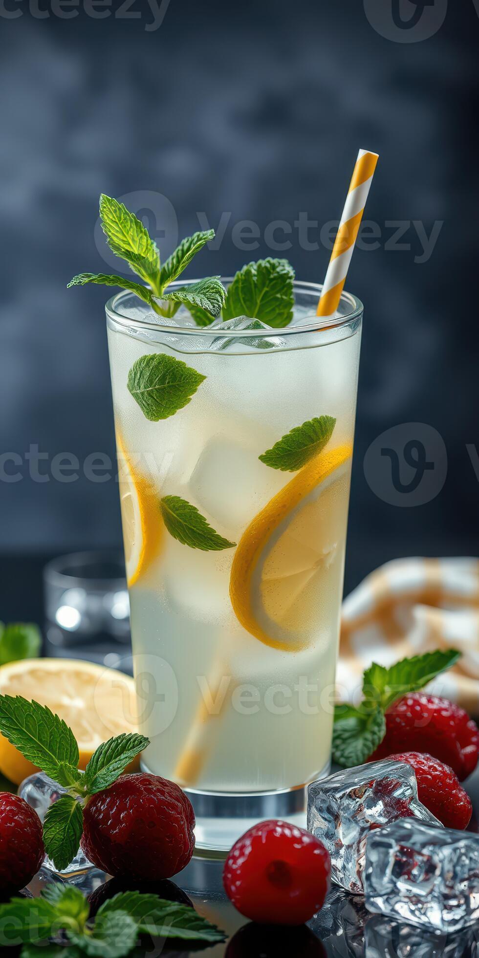 Refreshing citrus drink with lemon, mint, and berries served in tall glass at a summer gathering ...