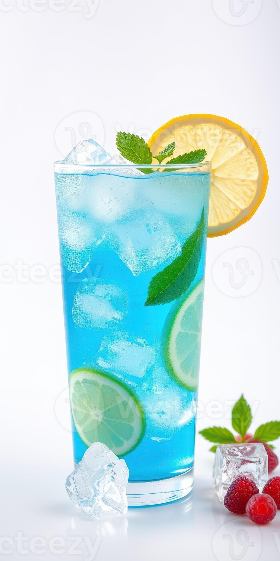 Refreshing blue cocktail with lemon and mint garnished with ice and fresh fruits in a clear ...