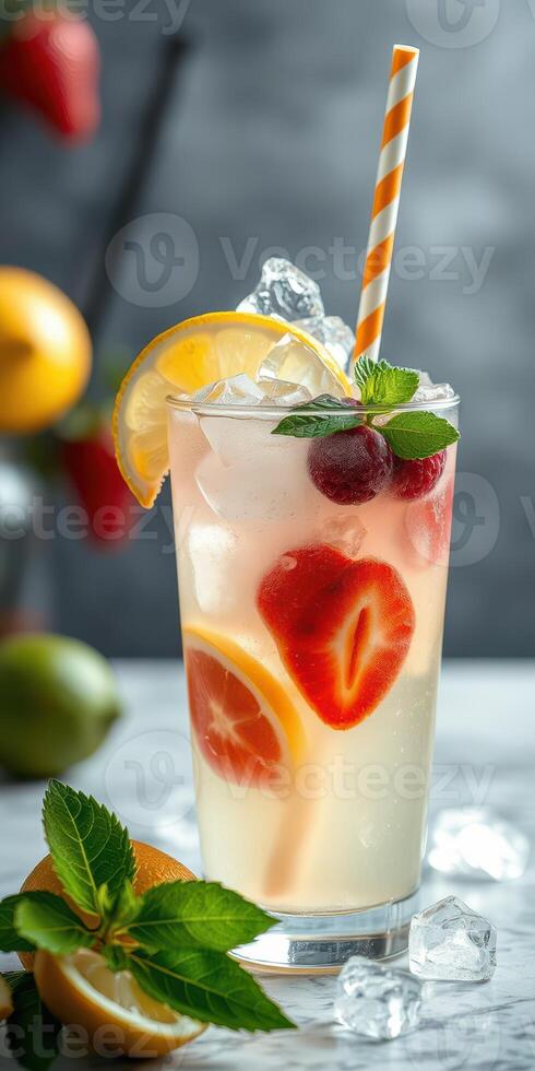 Refreshing fruit cocktail with strawberries, raspberries, and citrus garnishes served in a tall ...