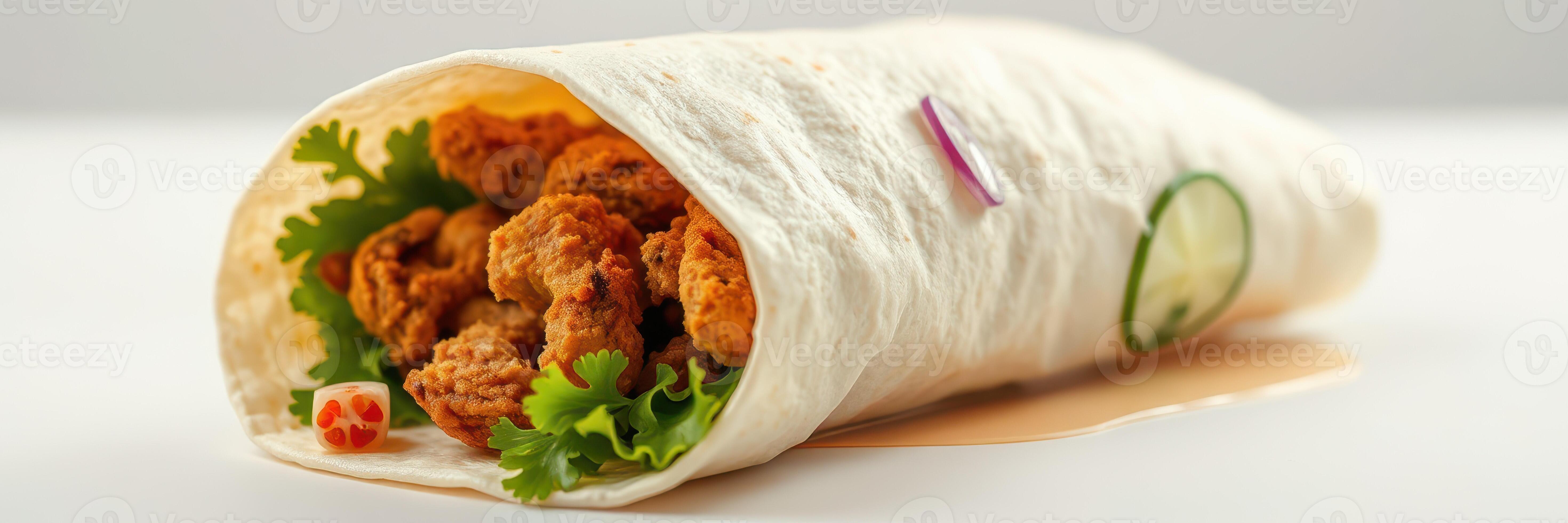 Fried chicken wrap featuring fresh vegetables, served on a plain ...