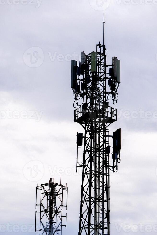 Telecommunication Towers Against Cloudy Sky Highlighting Modern Communication Infrastructure and ...