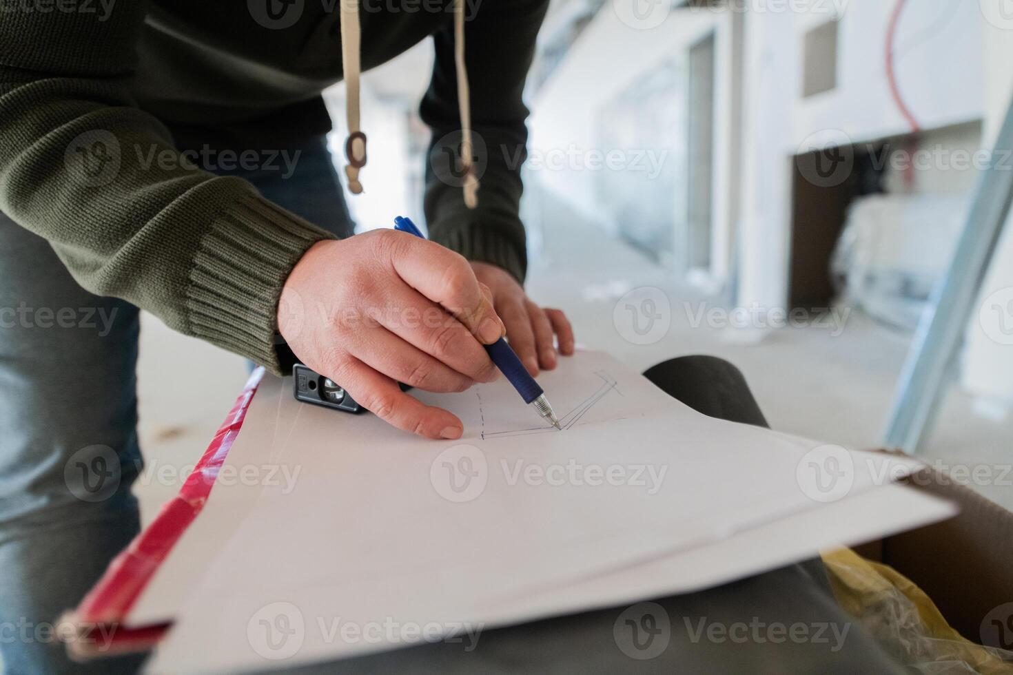 A close-up of an engineer's hand meticulously sketching an architectural project, capturing the ...