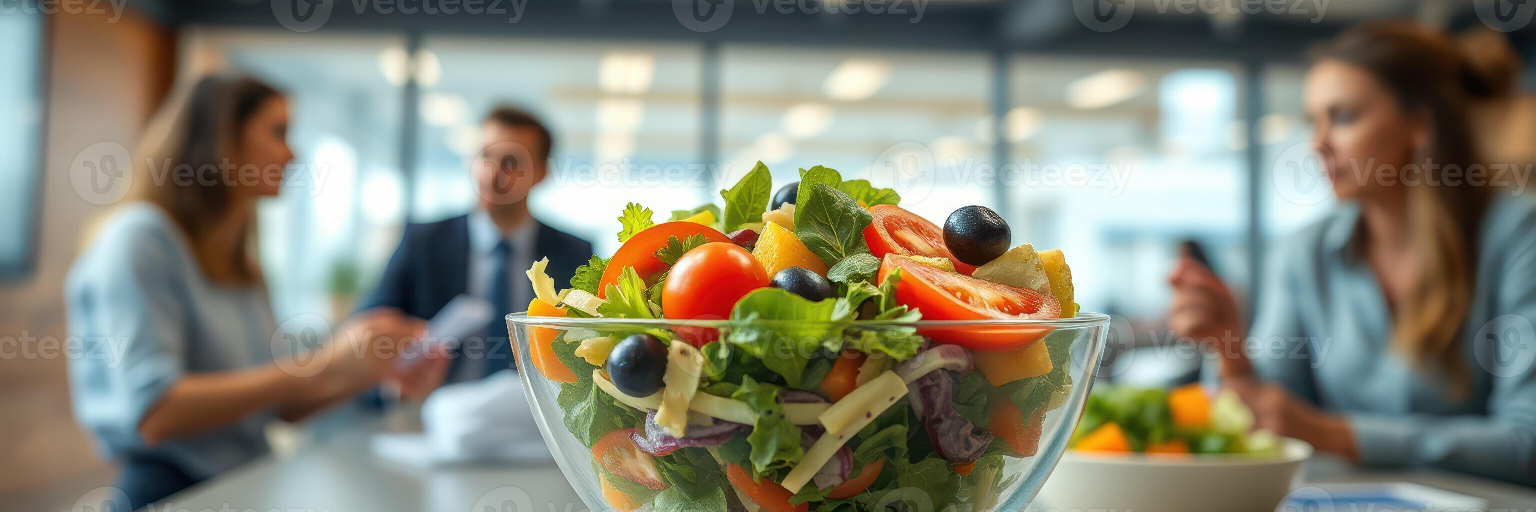 Fresh salad centerpiece highlights a business meeting with engaged ...