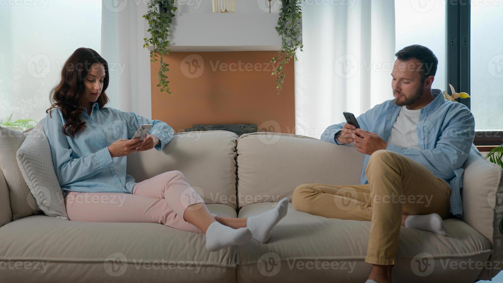 Caucasian gadget addict couple busy with phones scrolling social media smartphone gaming ...