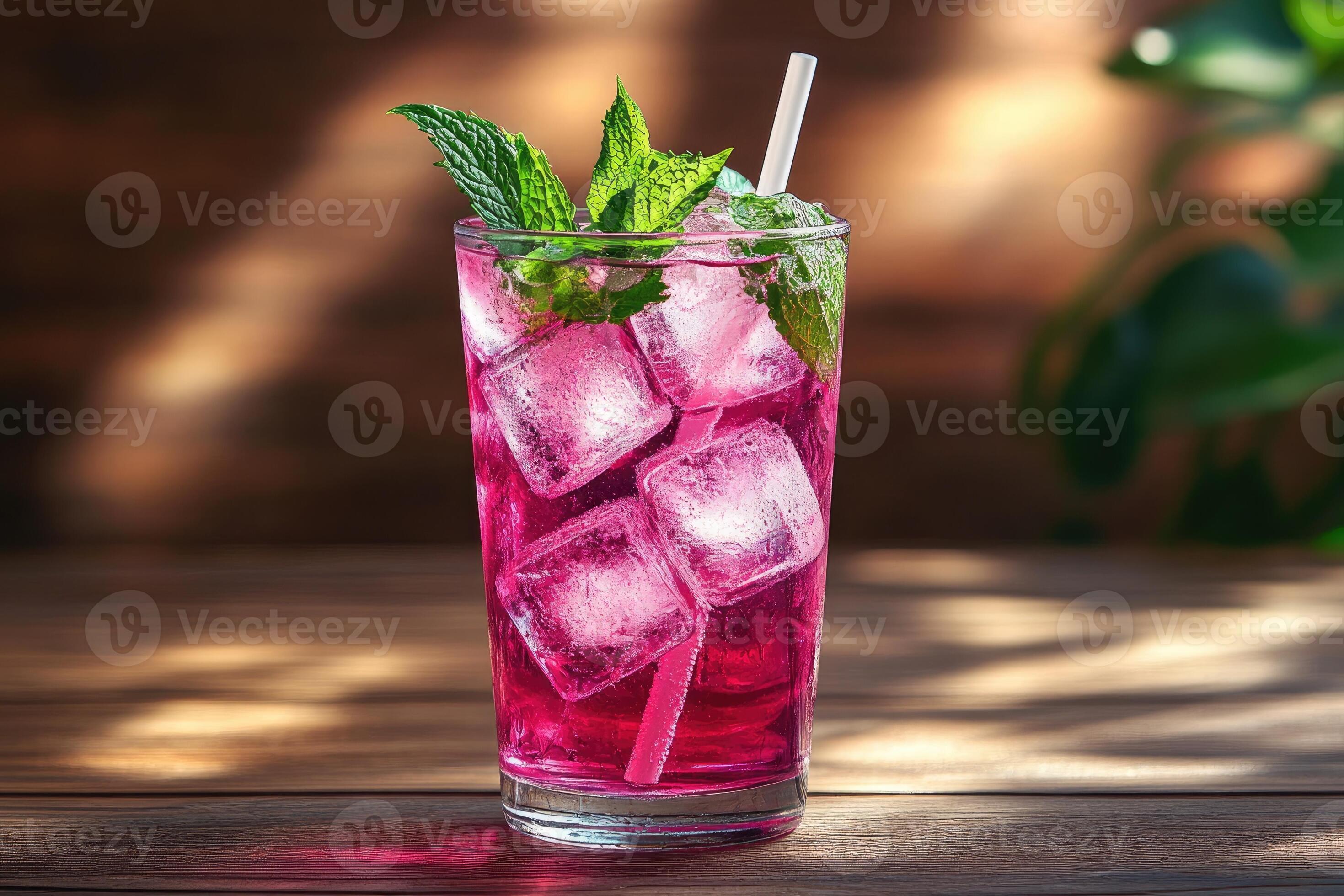 Refreshing pink lemonade with ice cubes, mint, and straw on wooden table 54323226 Stock Photo at ...