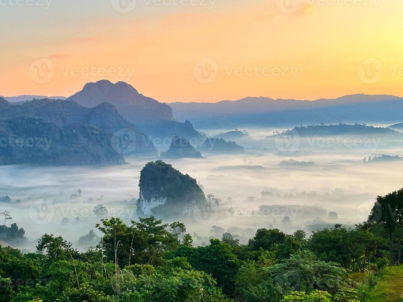Stunning sunrise over misty mountains with layers of fog blanketing the ... Stunning sunrise over misty mountains with layers of fog blanketing the ...