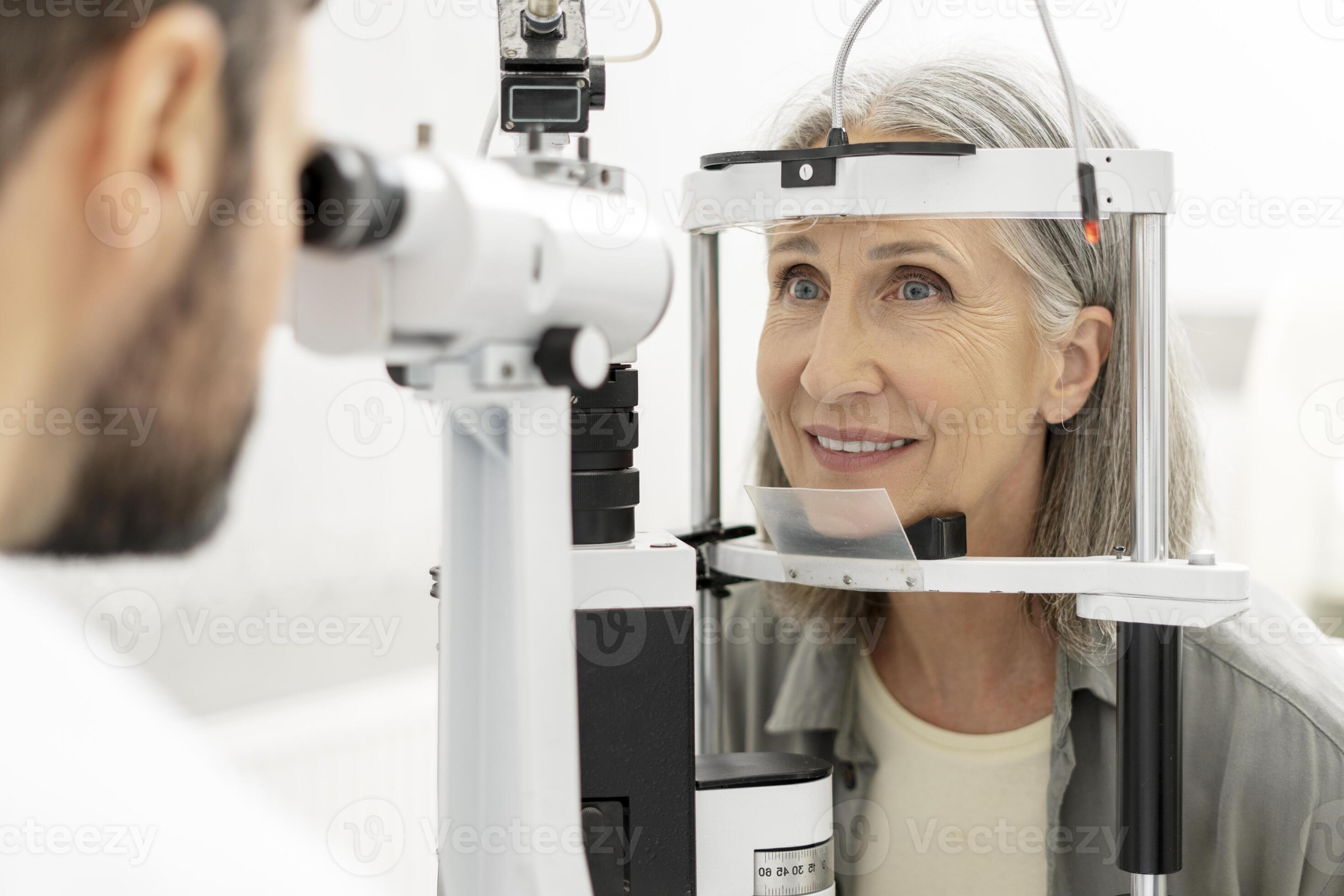 Senior woman undergoing eye exam with slit lamp by optometrist 54425080 Stock Photo at Vecteezy
