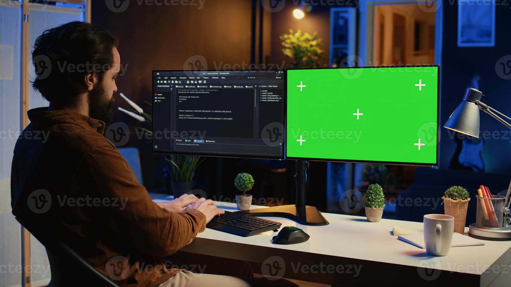Programmer typing complex code on green screen computer in neon lit ... Programmer typing complex code on green screen computer in neon lit ...