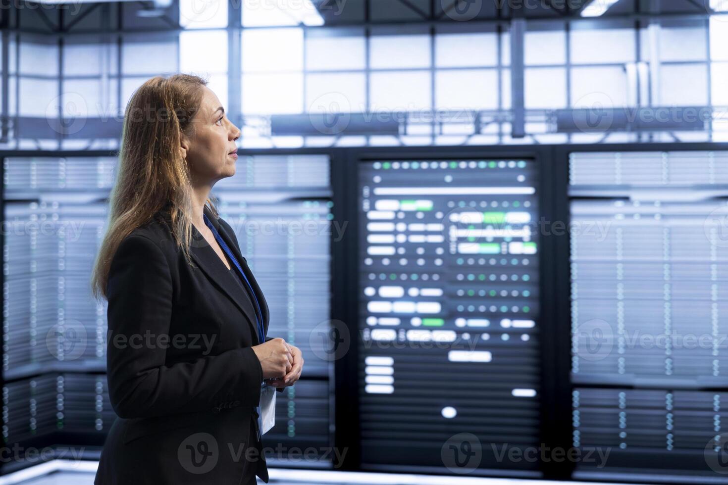 Engineer Walking Between Server Rows In Data Center Doing Yearly