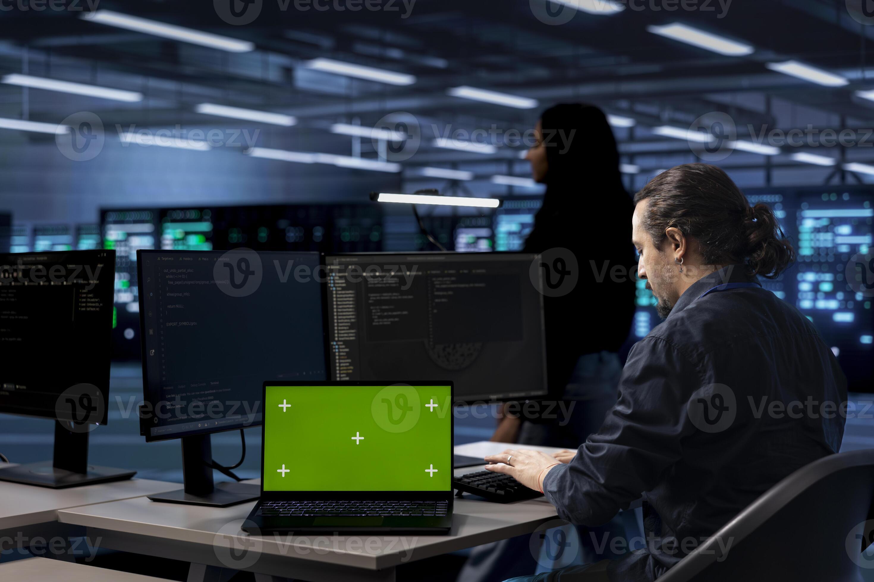 Admin In Data Center Uses Green Screen Laptop To Update Systems Protecting Servers From