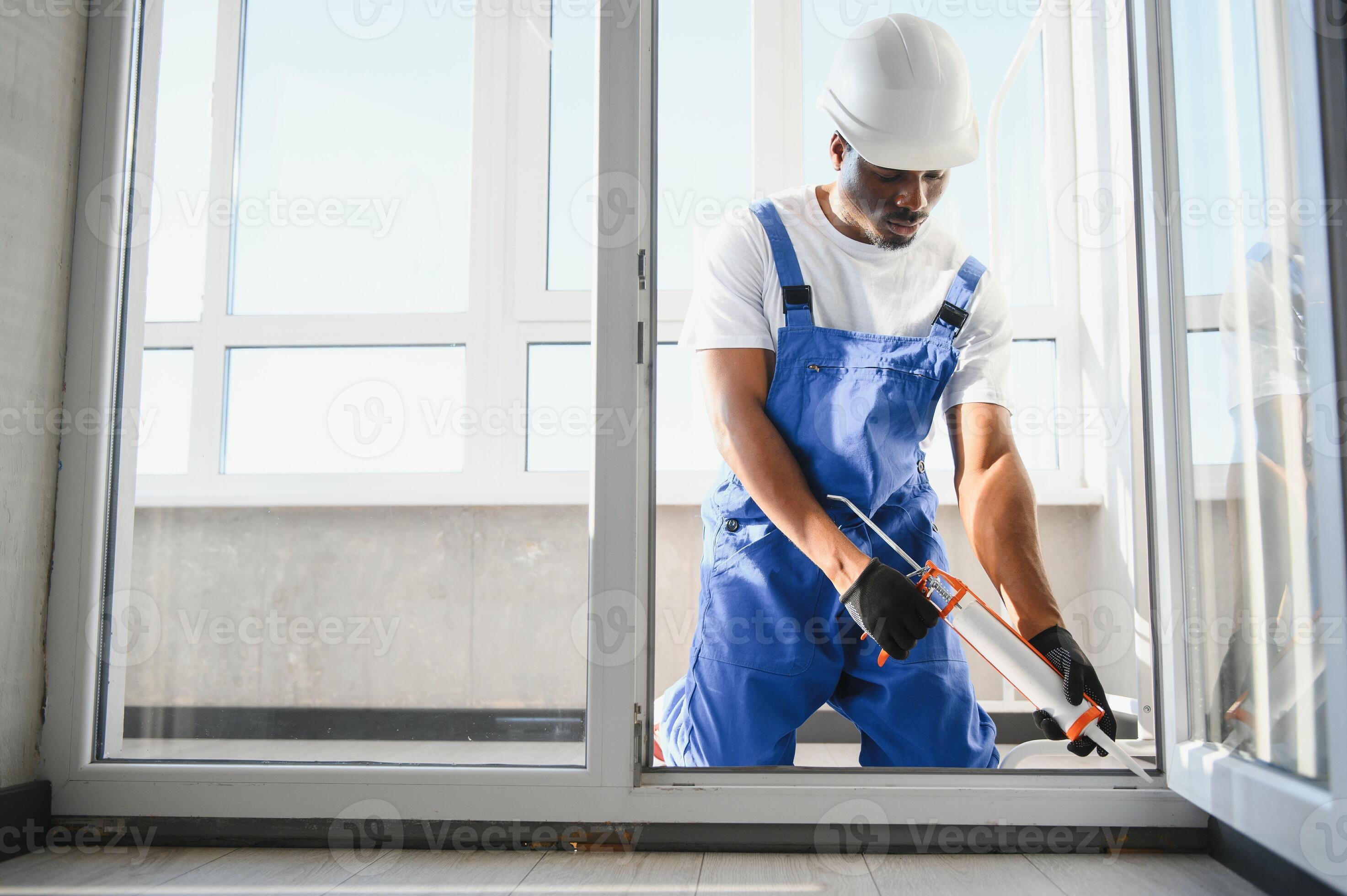 Young Male Worker Applying Silicone Sealant With Silicone Gun 54578600