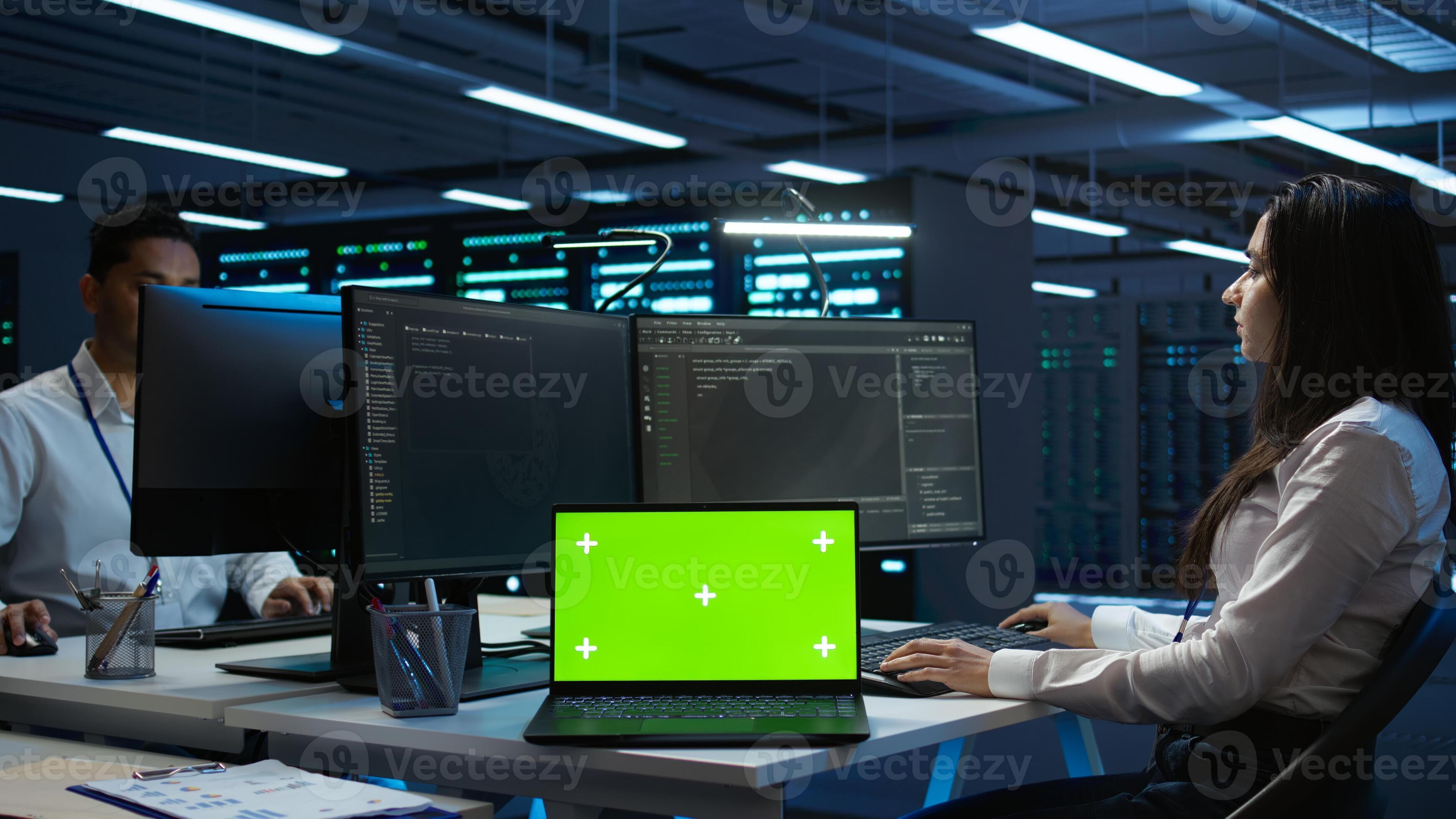 Programmers in data center manage and maintain databases using chroma key notebook, ensuring ...