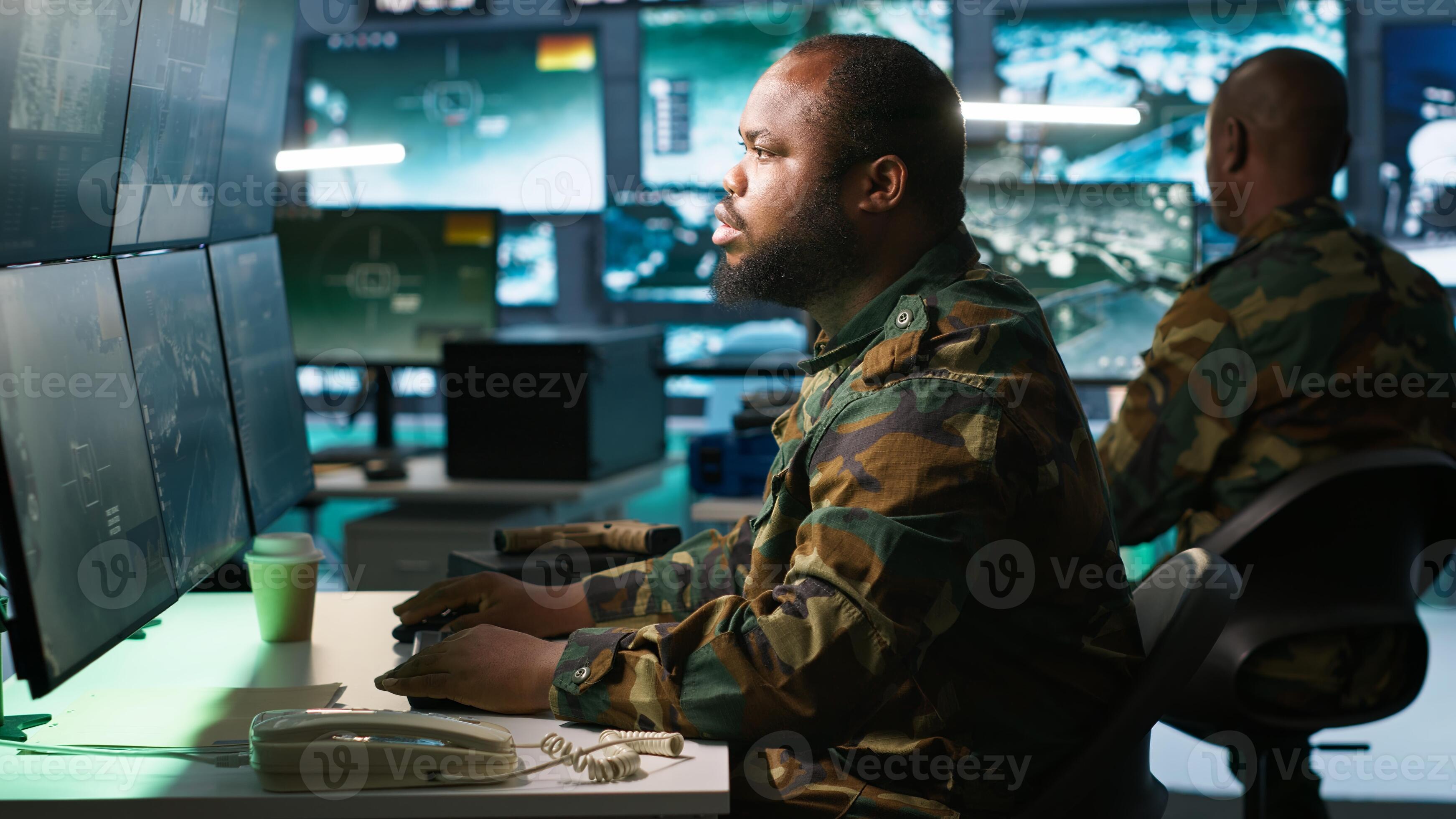 Intelligence corps expert in military HQ base gathering information on enemy troops. Officer ...