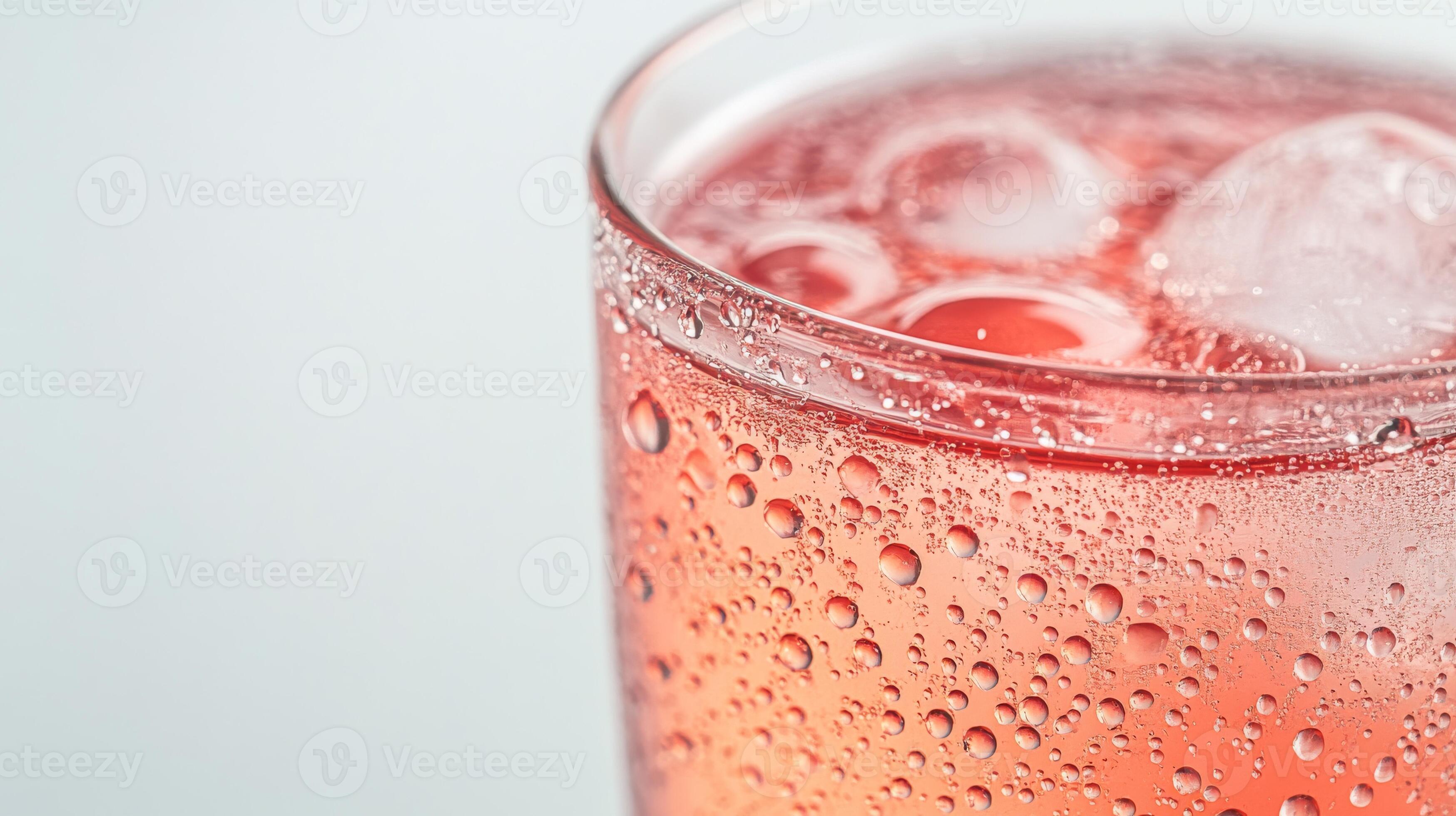 A refreshing cold drink in a glass with condensation droplets on a white background. 54923794 ...