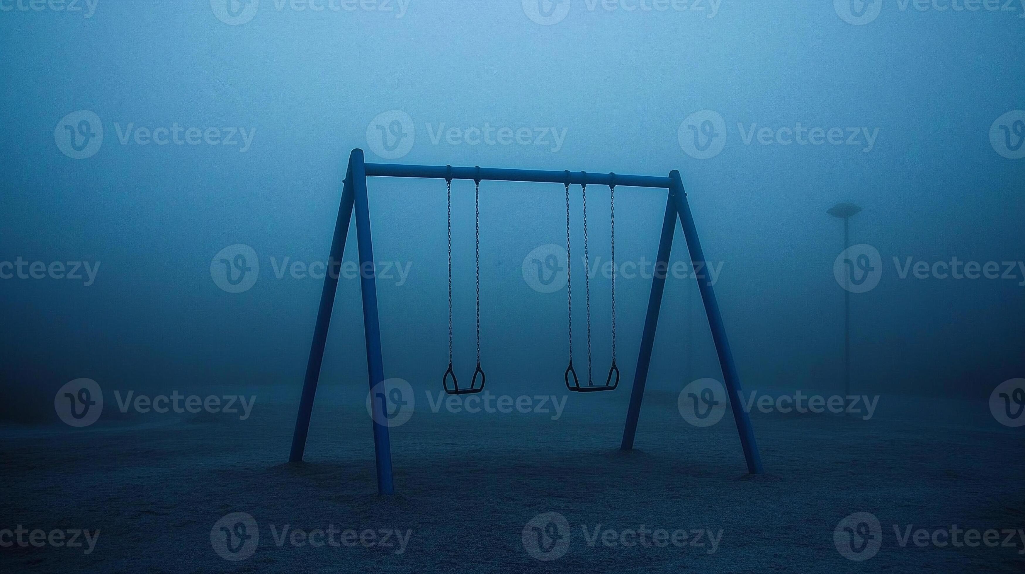 Atmospheric photography of foggy deserted playground with empty swings in a mysterious misty ...