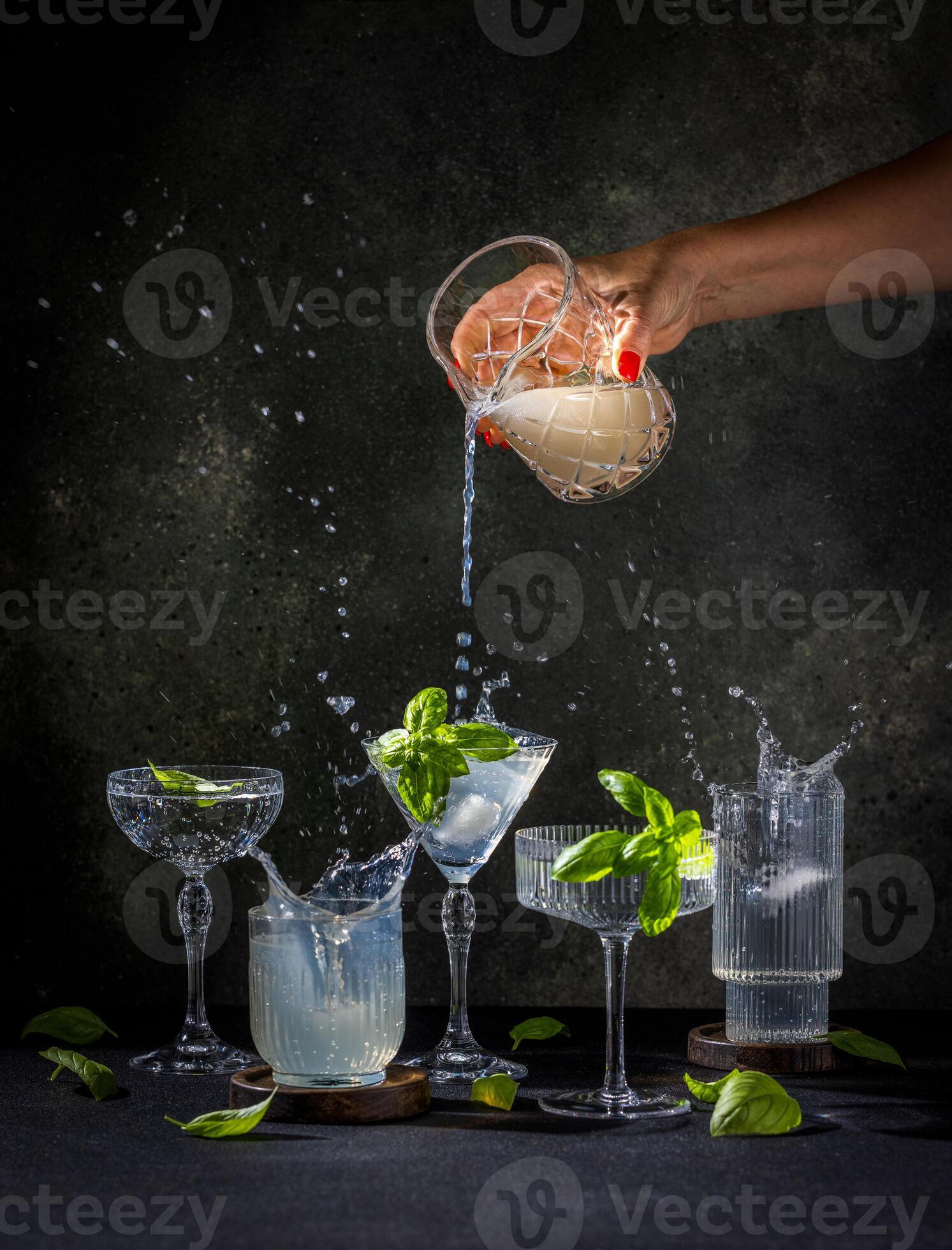 Bartender pouring drink into cocktail glass with ice and basil 54966270 Stock Photo at Vecteezy
