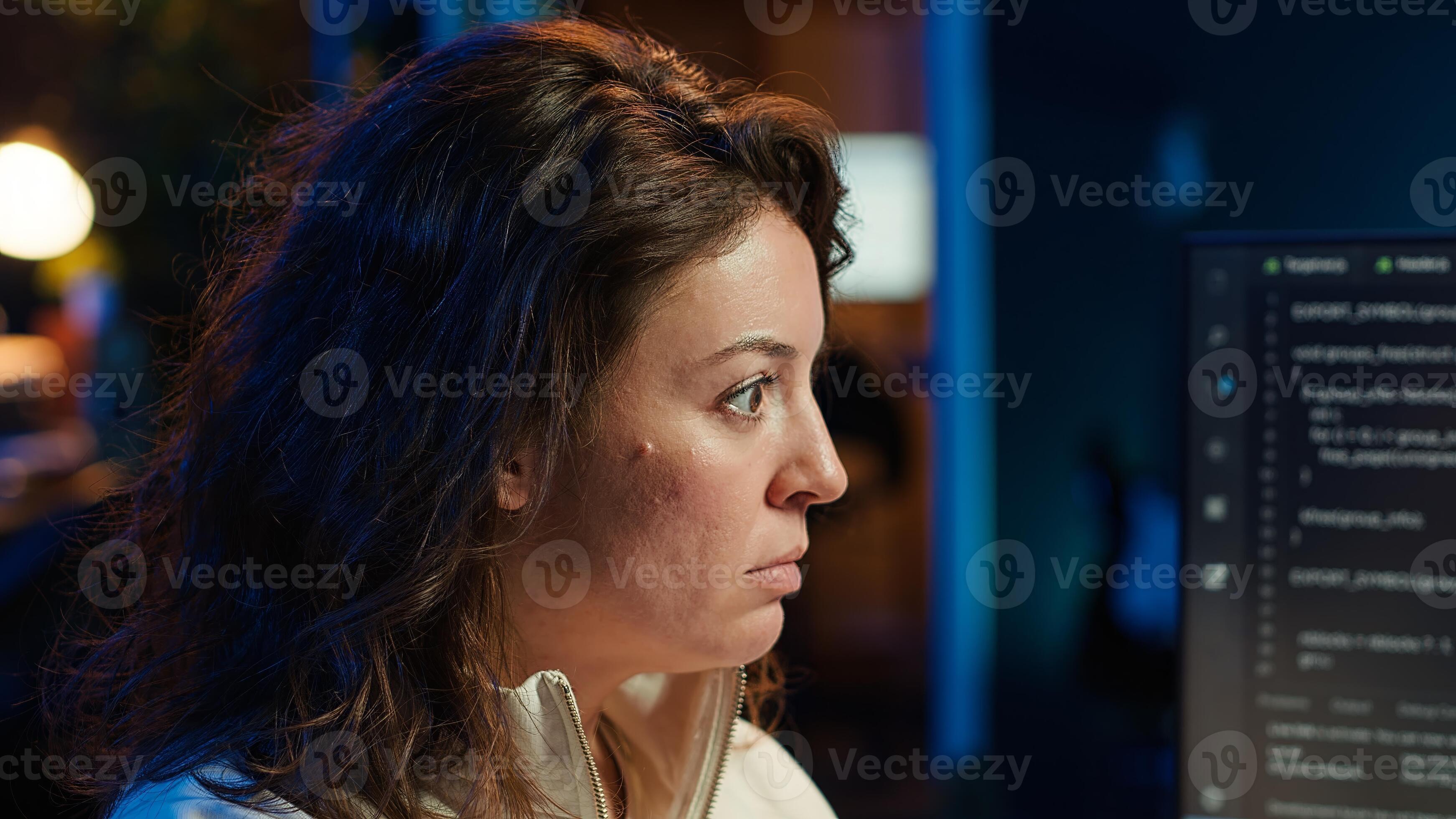 IT expert focused on looking for company security vulnerabilities and injected malware, close up ...