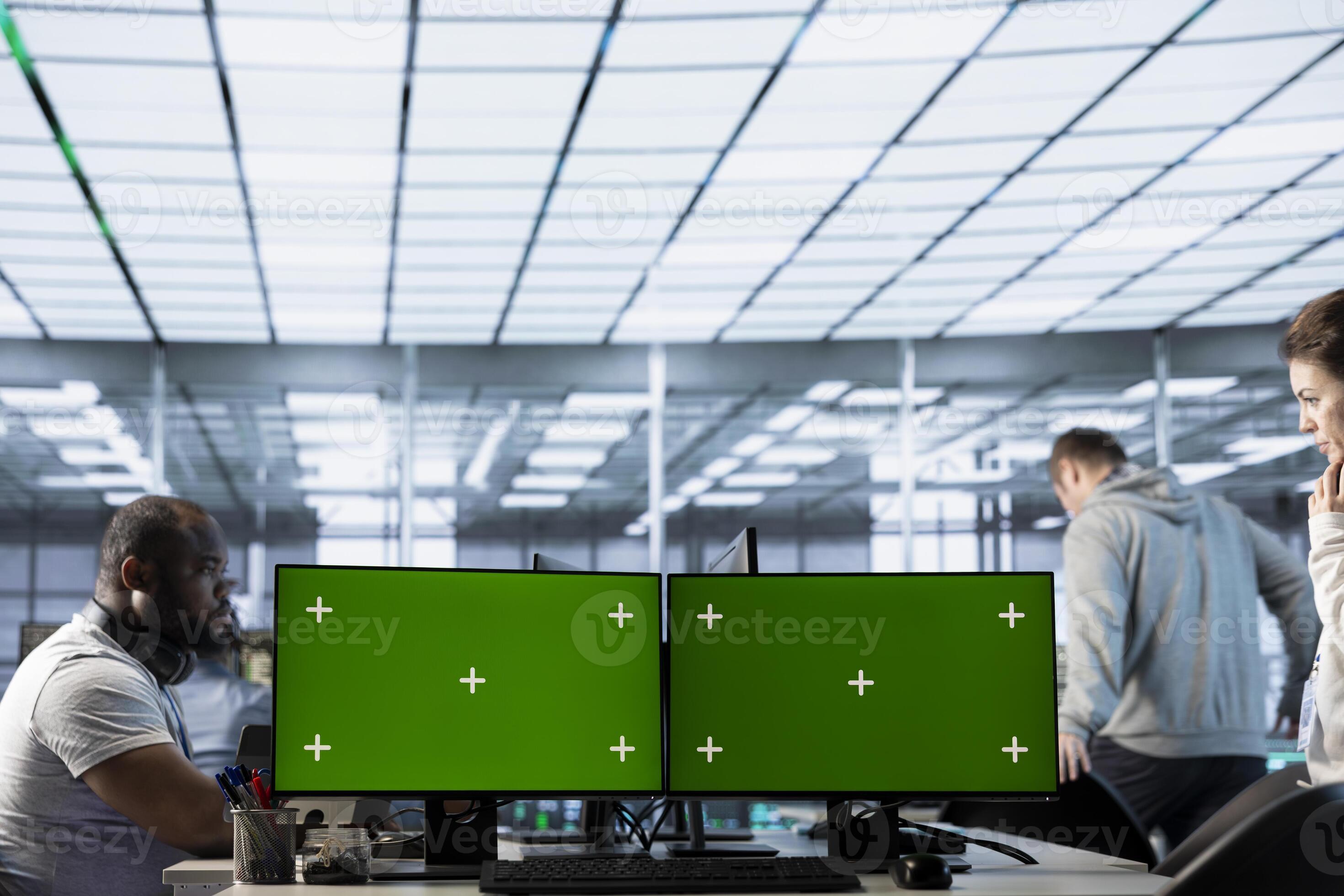 Green screen computer used by engineers working in high tech server hub processing vast amounts ...