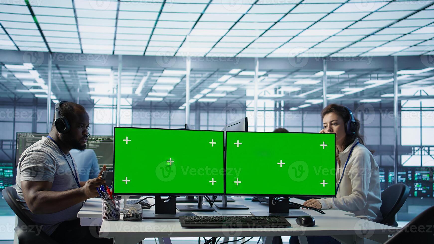 Close up of multi monitor isolated screen computer in data center used for supervising server ...