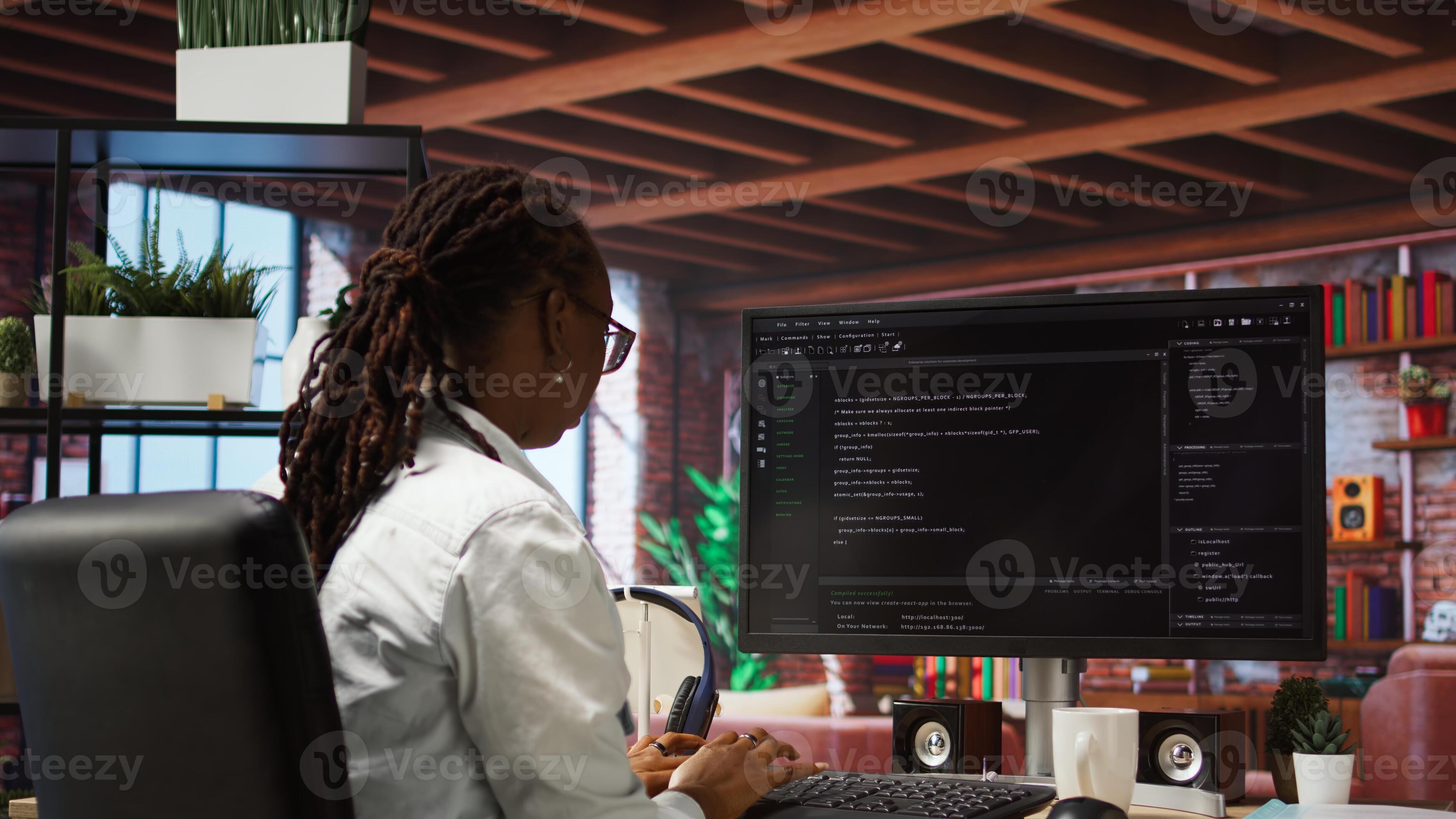 Programmer types code into PC, entering commands, running script. African american IT ...