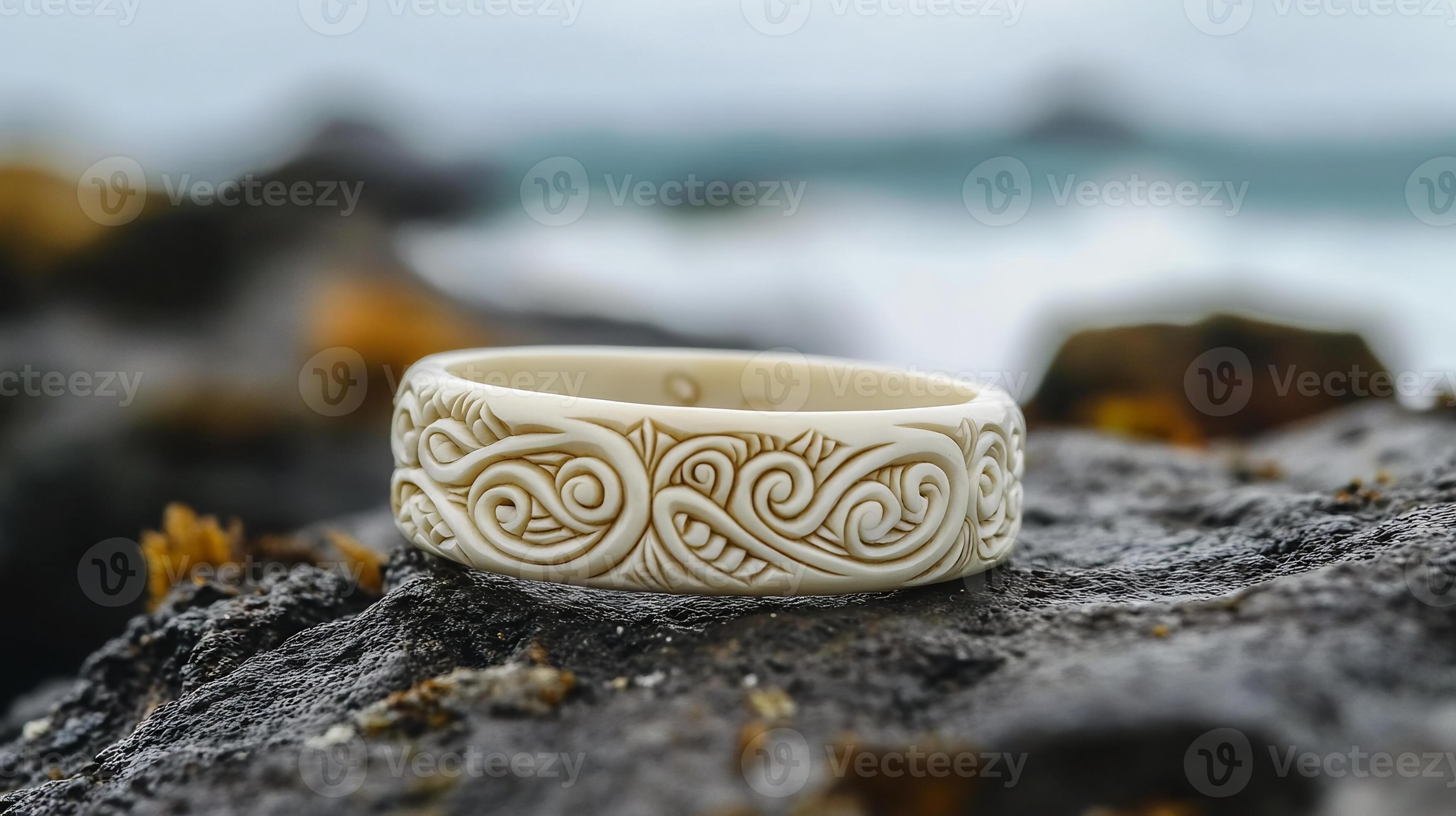 Beautifully crafted 'Maori' bone carving bracelet featuring traditional designs motifs worn by ...