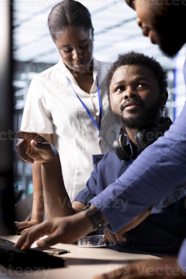 Data center coworkers doing brainstorming, using programming languages to construct algorithms ...