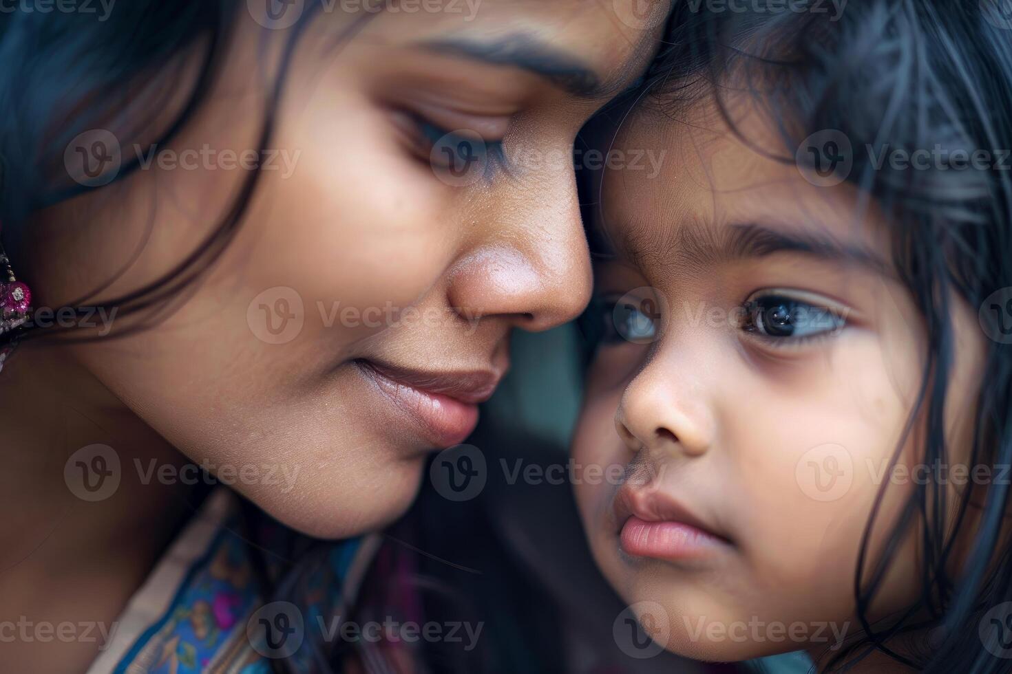 Indian mother sharing a tender moment with her daughter 55363350 Stock Photo at Vecteezy