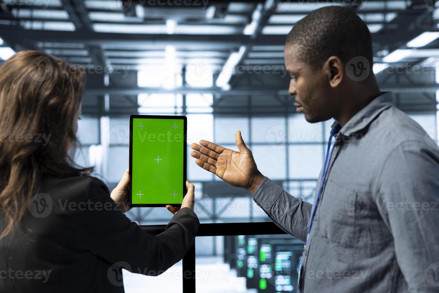 System Administrators In Data Center Use Green Screen Tablet To