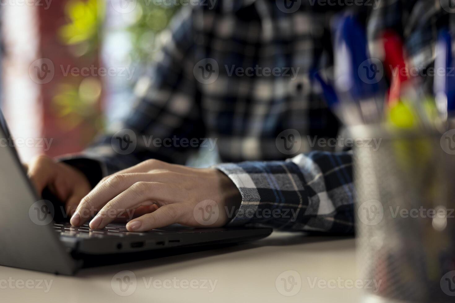 Worker at desk completing spreadsheets on notebook, entering numerical ... Worker at desk completing spreadsheets on notebook, entering numerical ...