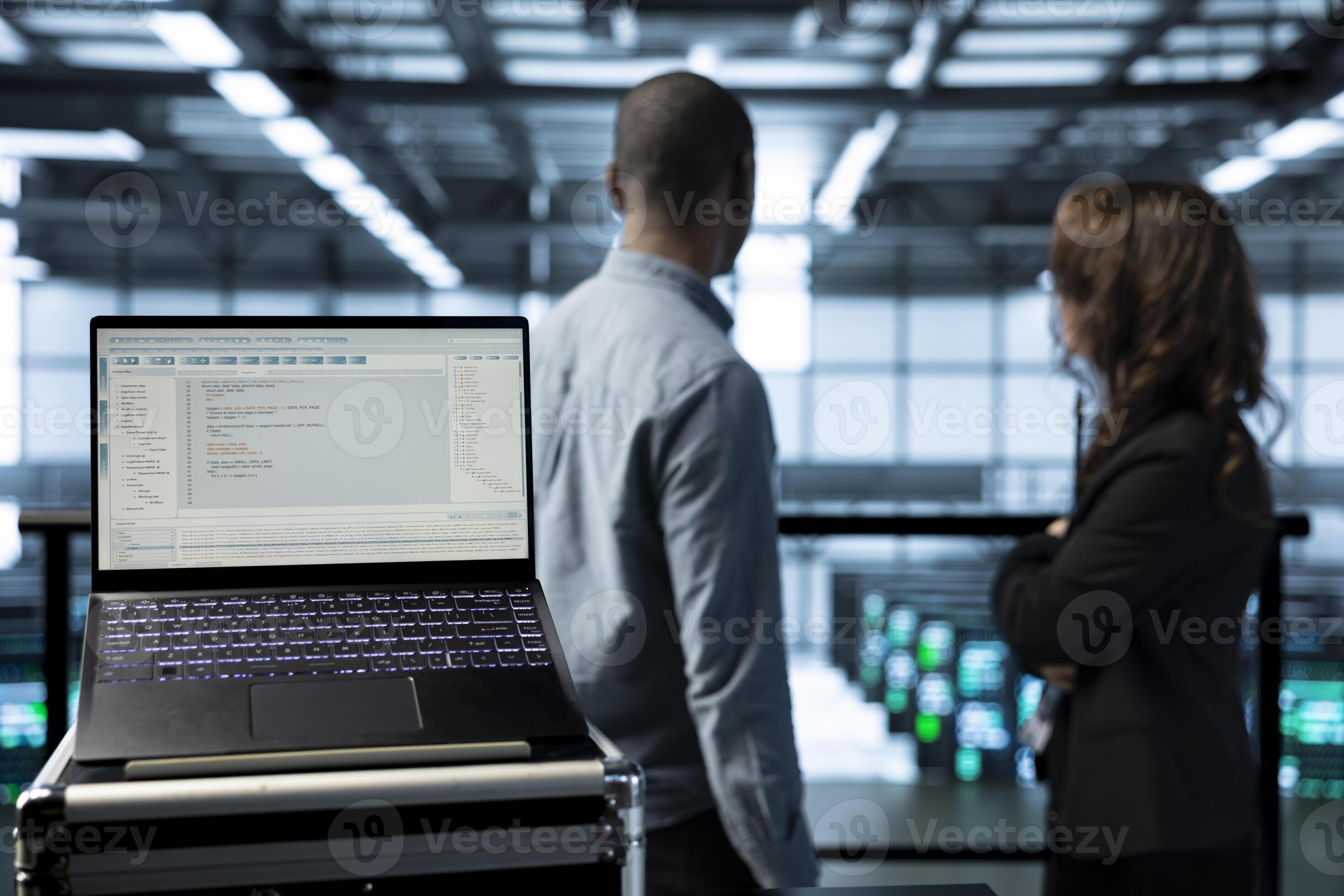 Focus on lines of code on laptop display used by teamworking data ...