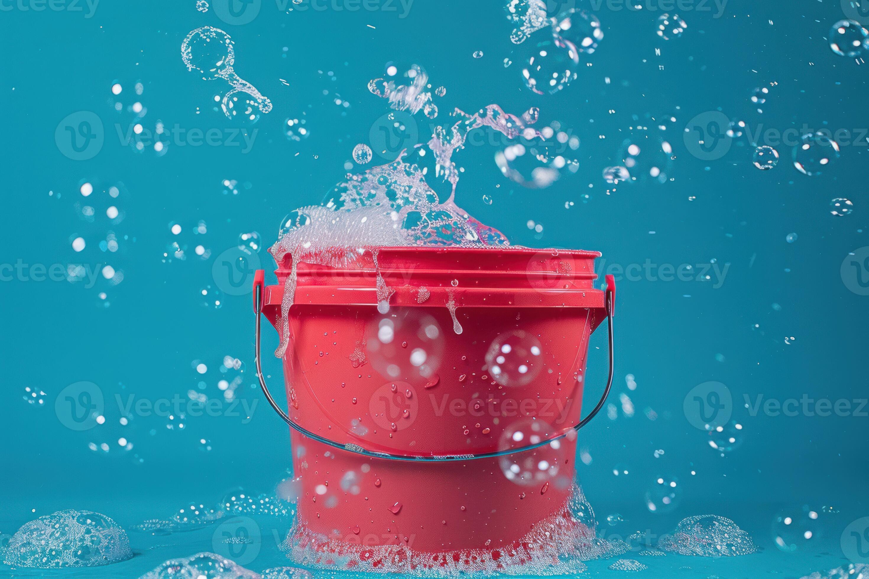 Red bucket overflowing with soapy water splashing on blue background ...