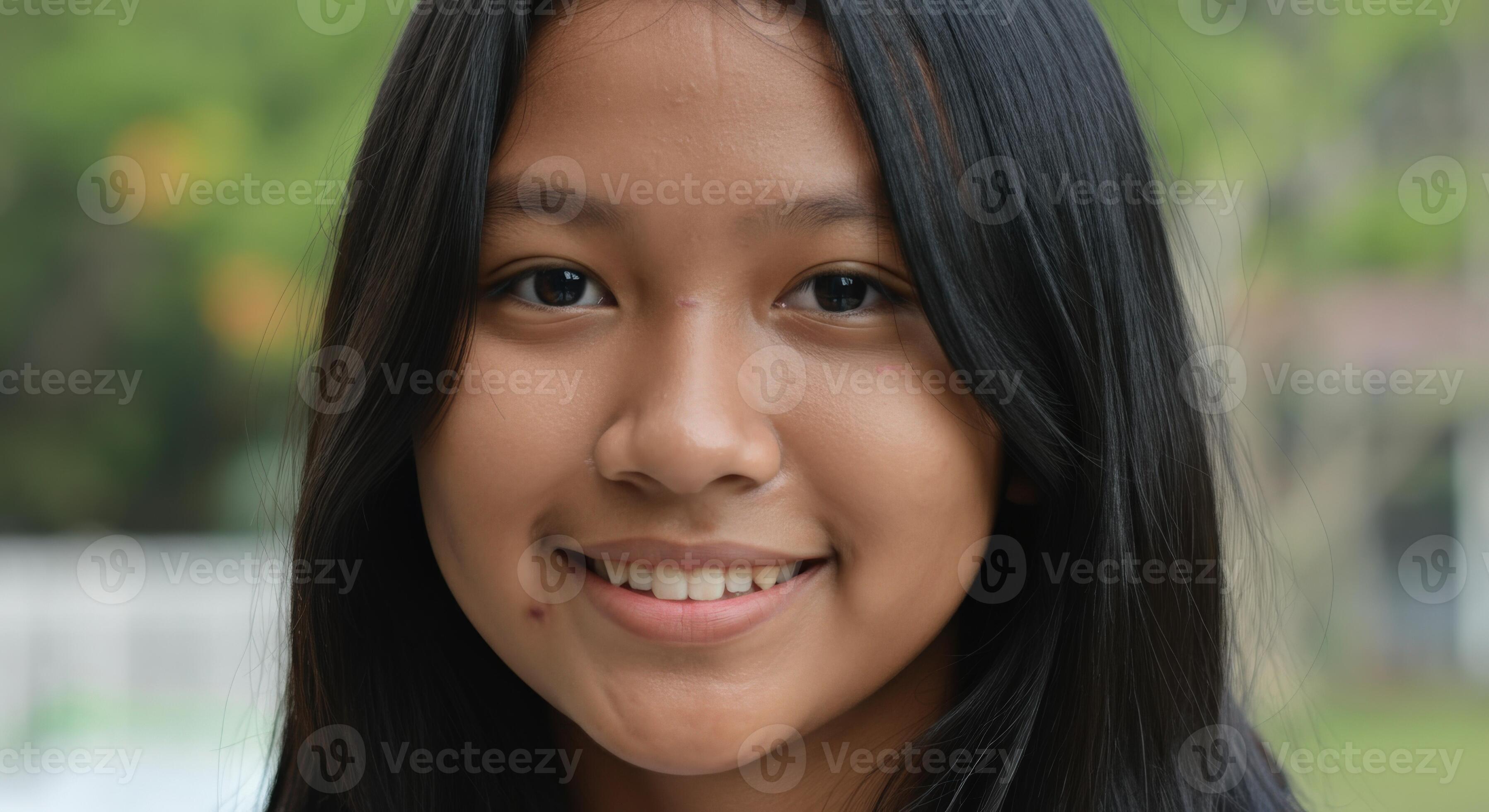 Asian teenage girl smiling outdoors in natural lighting for lifestyle ...